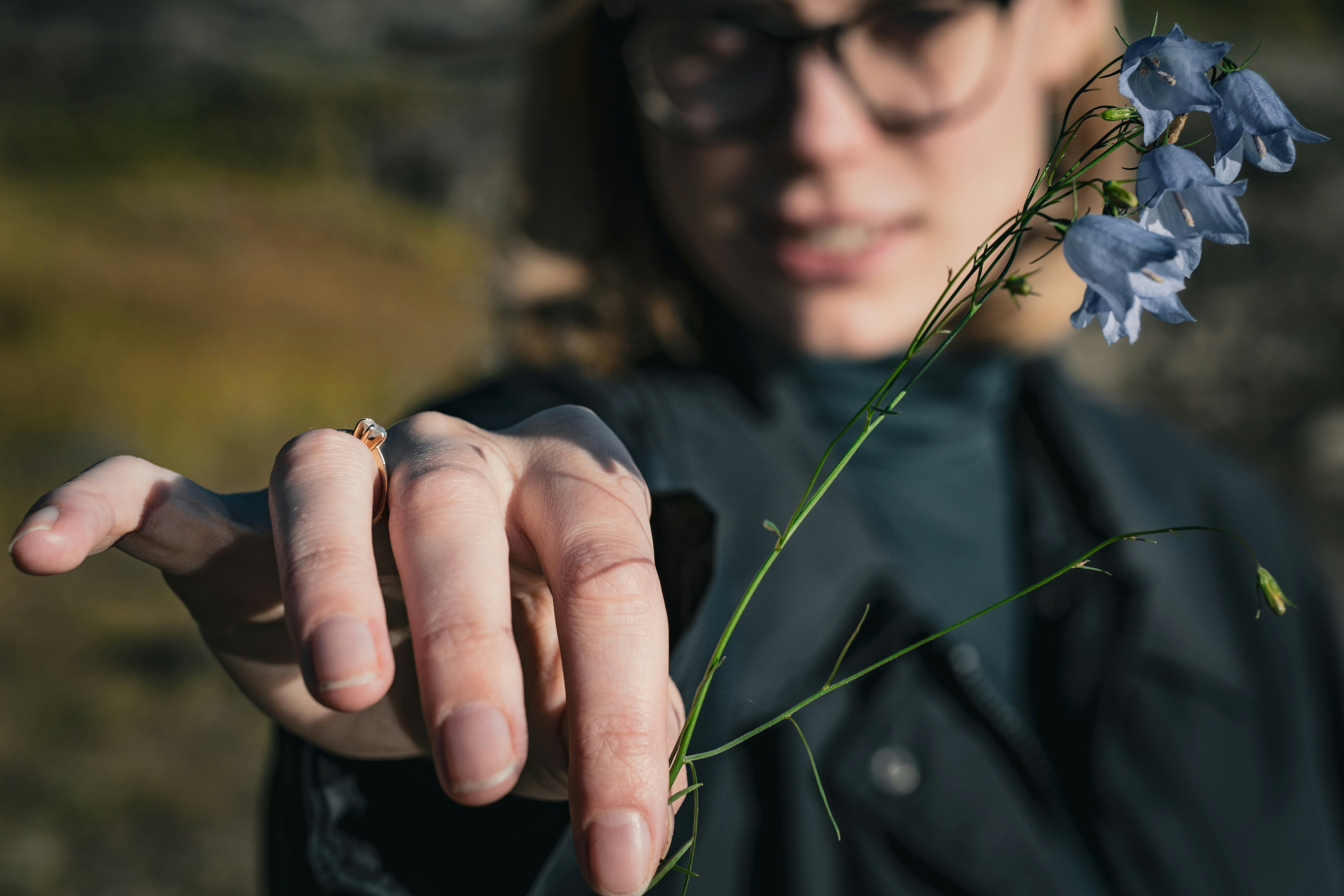 A person holding a flower in their hand photo – Free Flower Image on ...