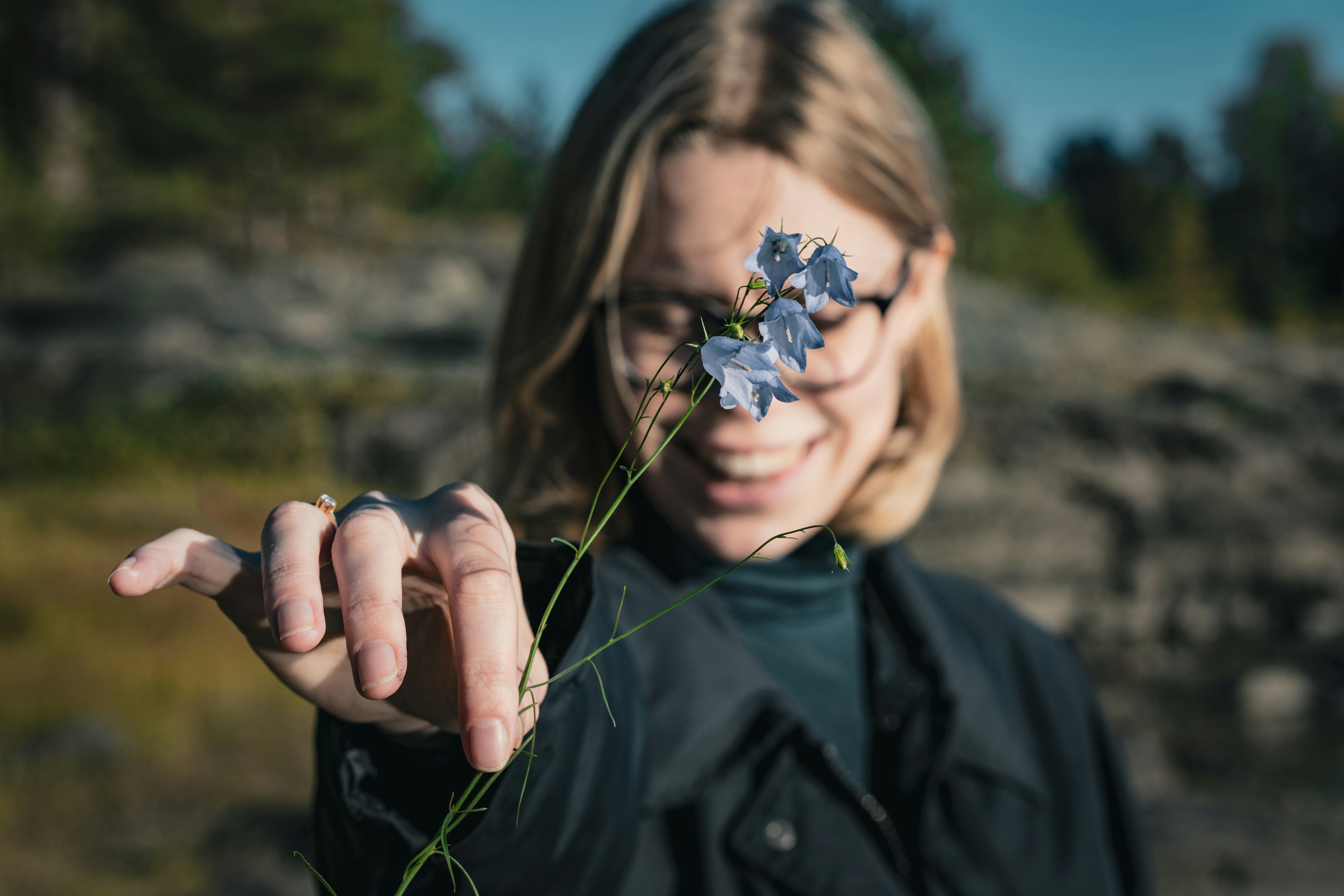a woman holding a flower in her hand