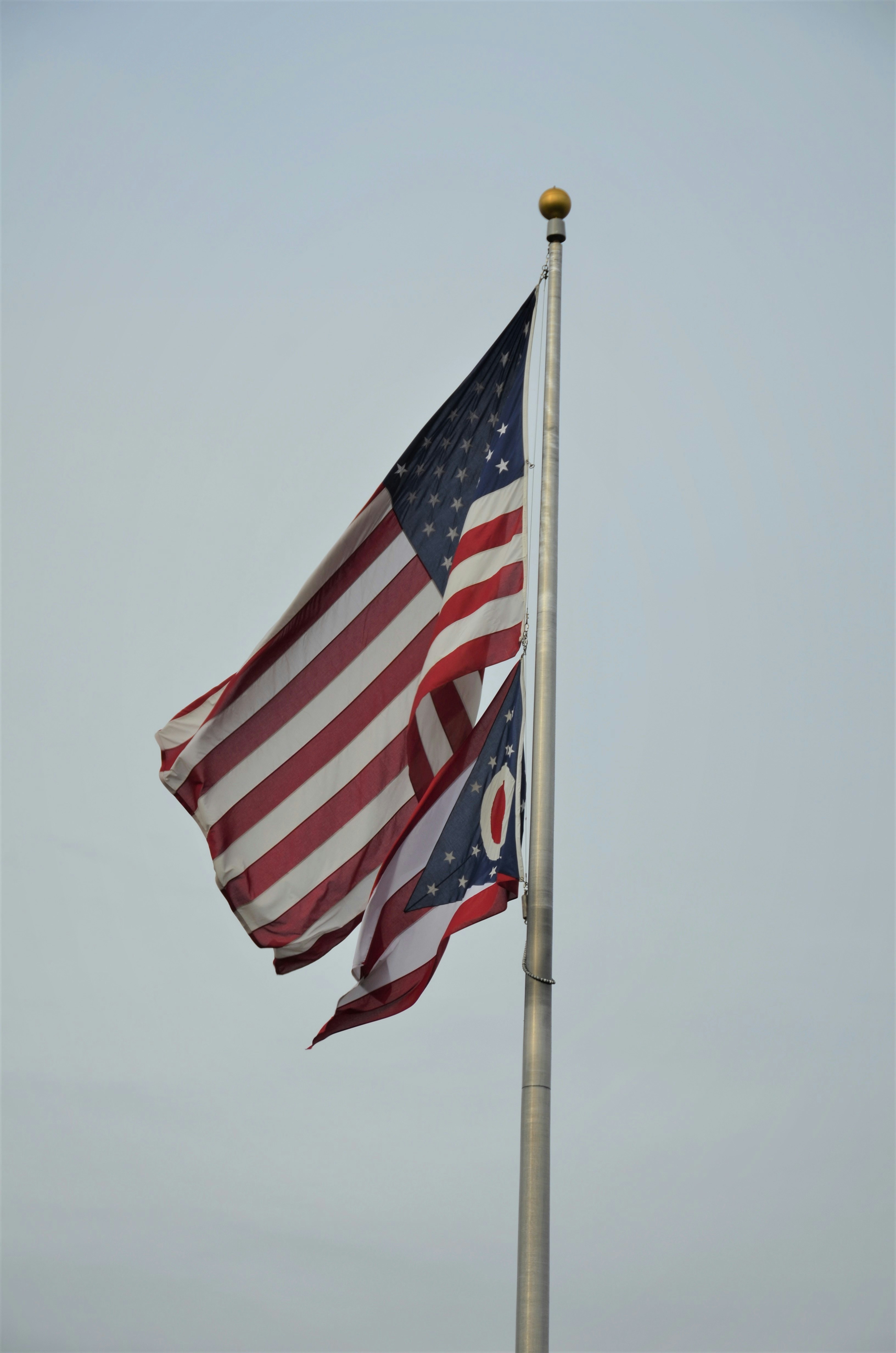Windswept Banner: The American Flag Rests Along a Steel Pole