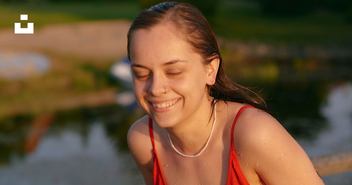 A Woman In A Red Bathing Suit Holding A Bottle Of Water Photo Free Portrait Image On Unsplash