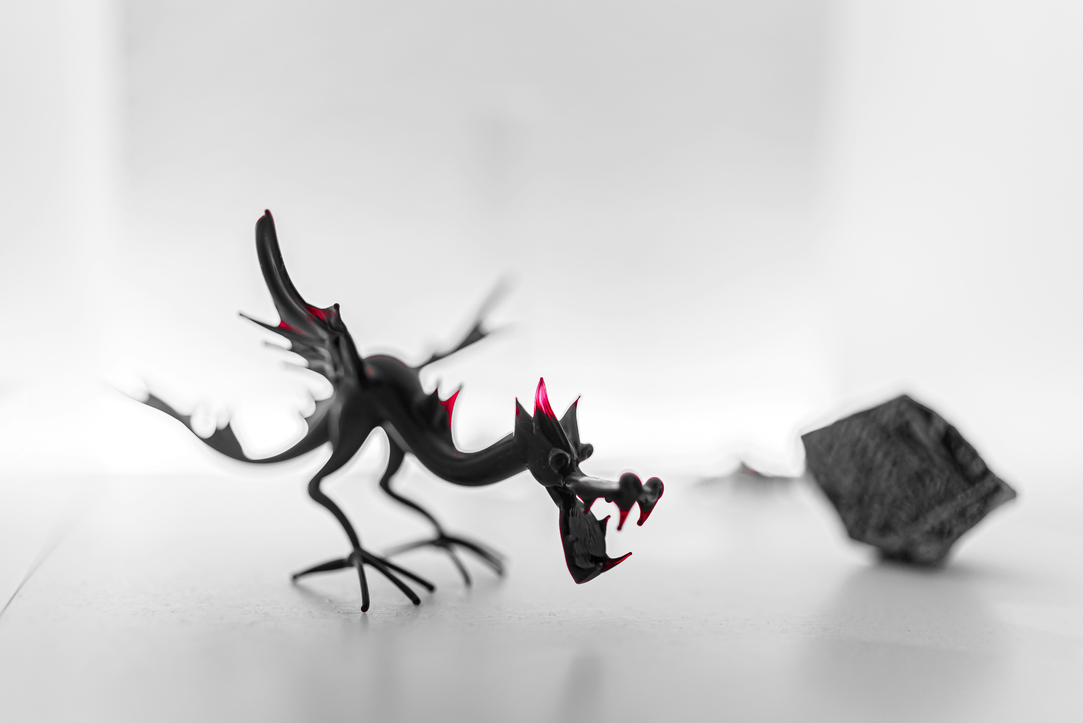 a black and white photo of a dragon figurine