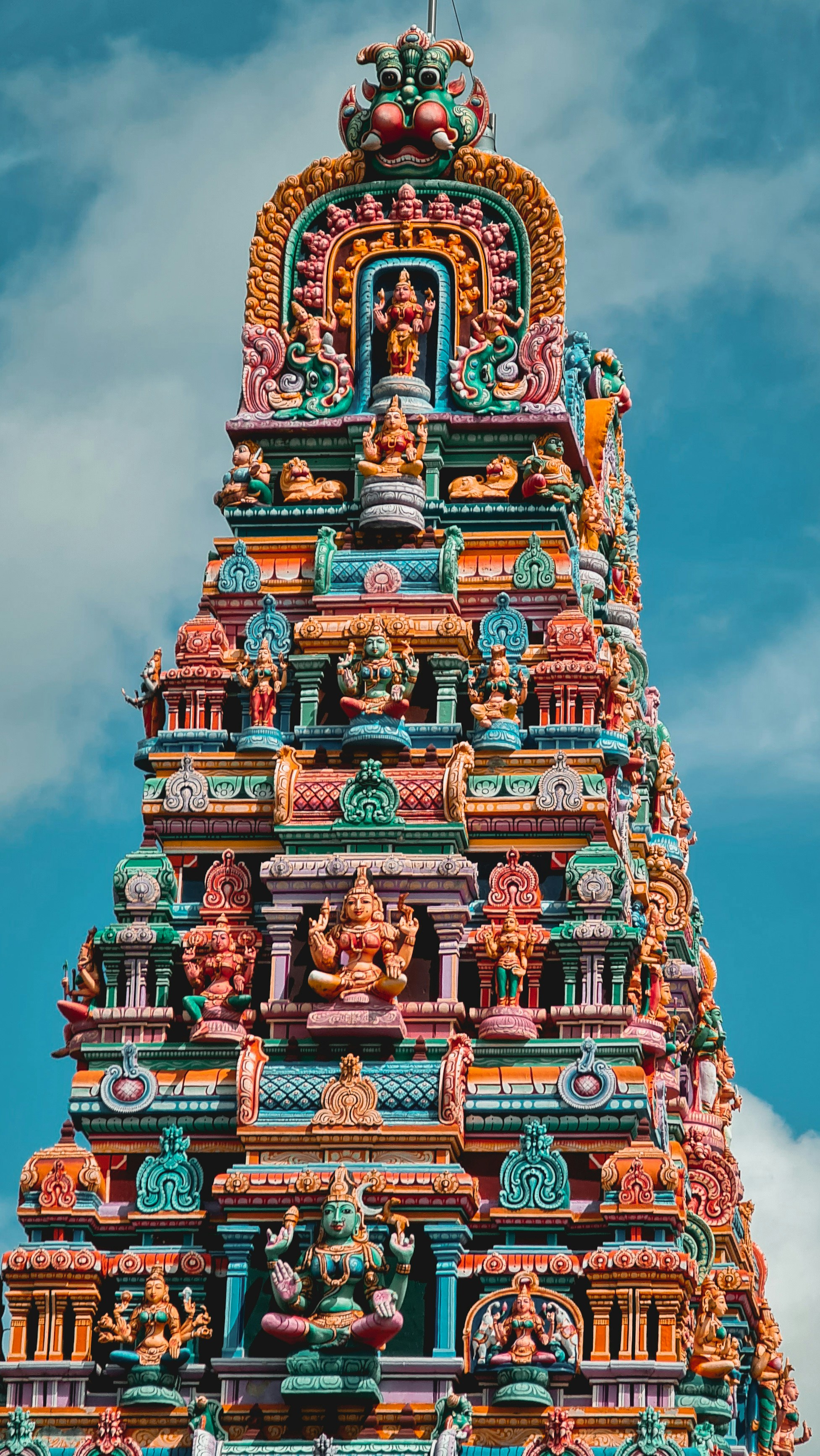 A tall tower with a clock on top of it photo – Free Hindu god Image on ...