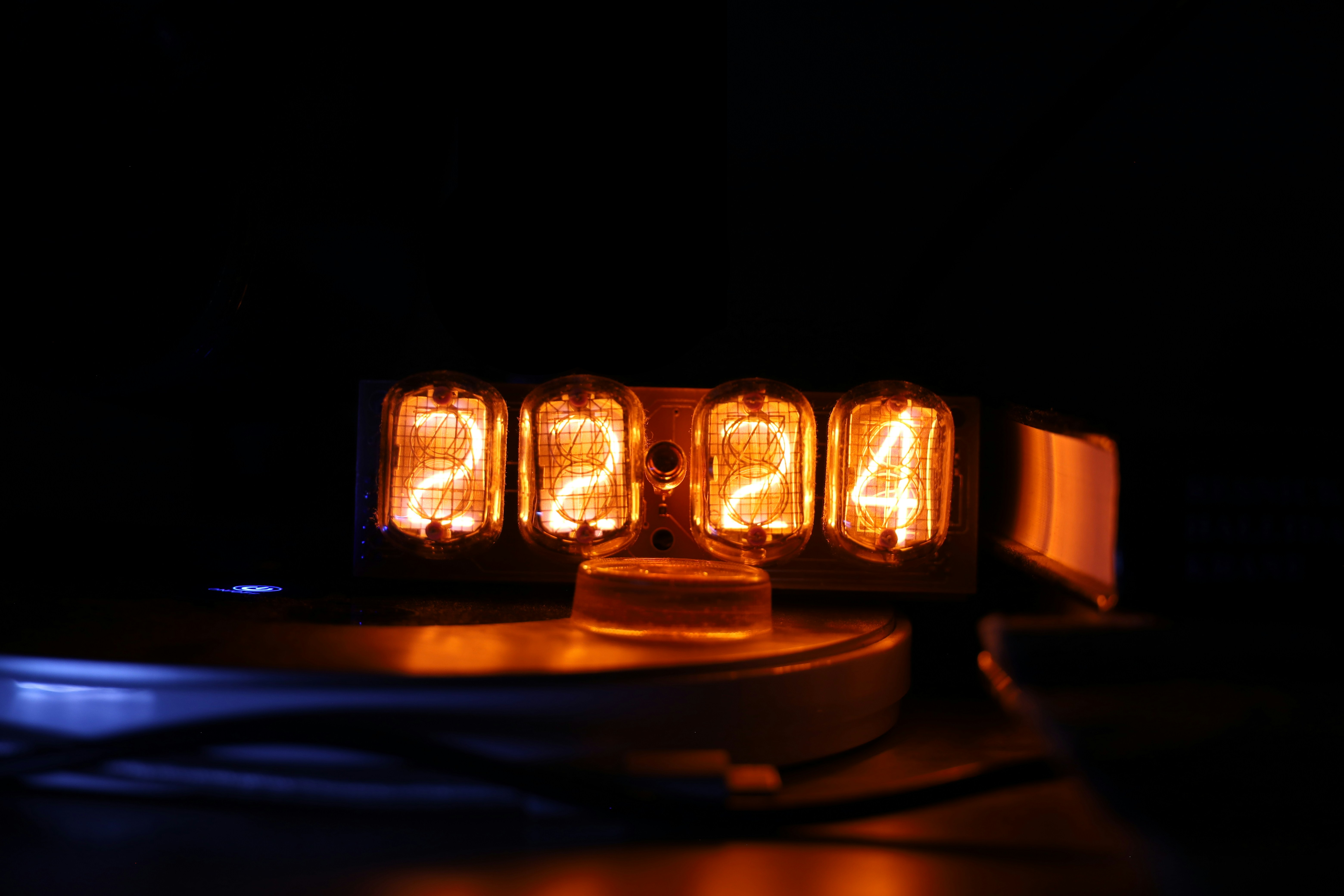 Flickering Timekeepers: Orange Nixie Digits in a Dusk-lit Studio