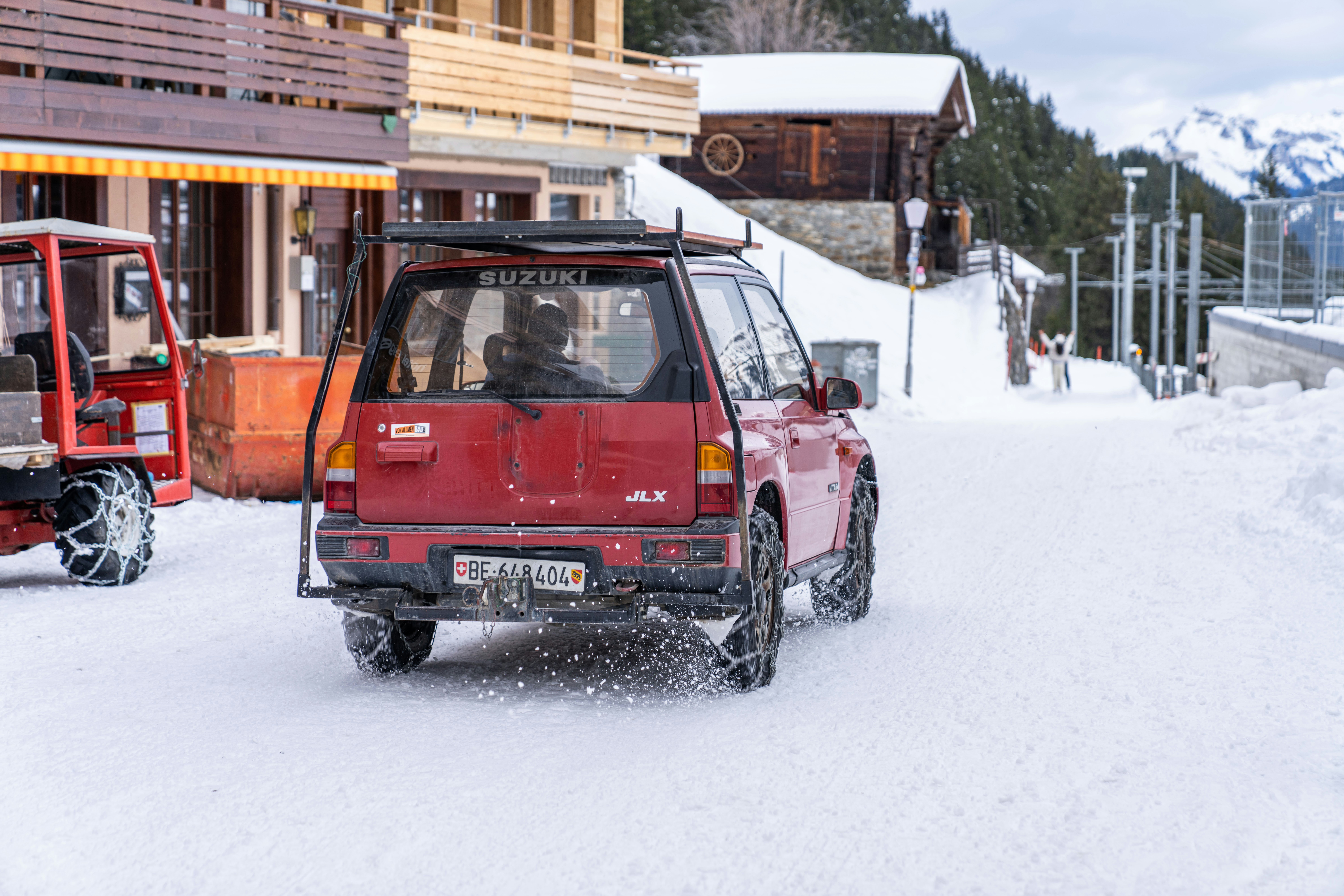 Red SUV in Snowy Alpine Village