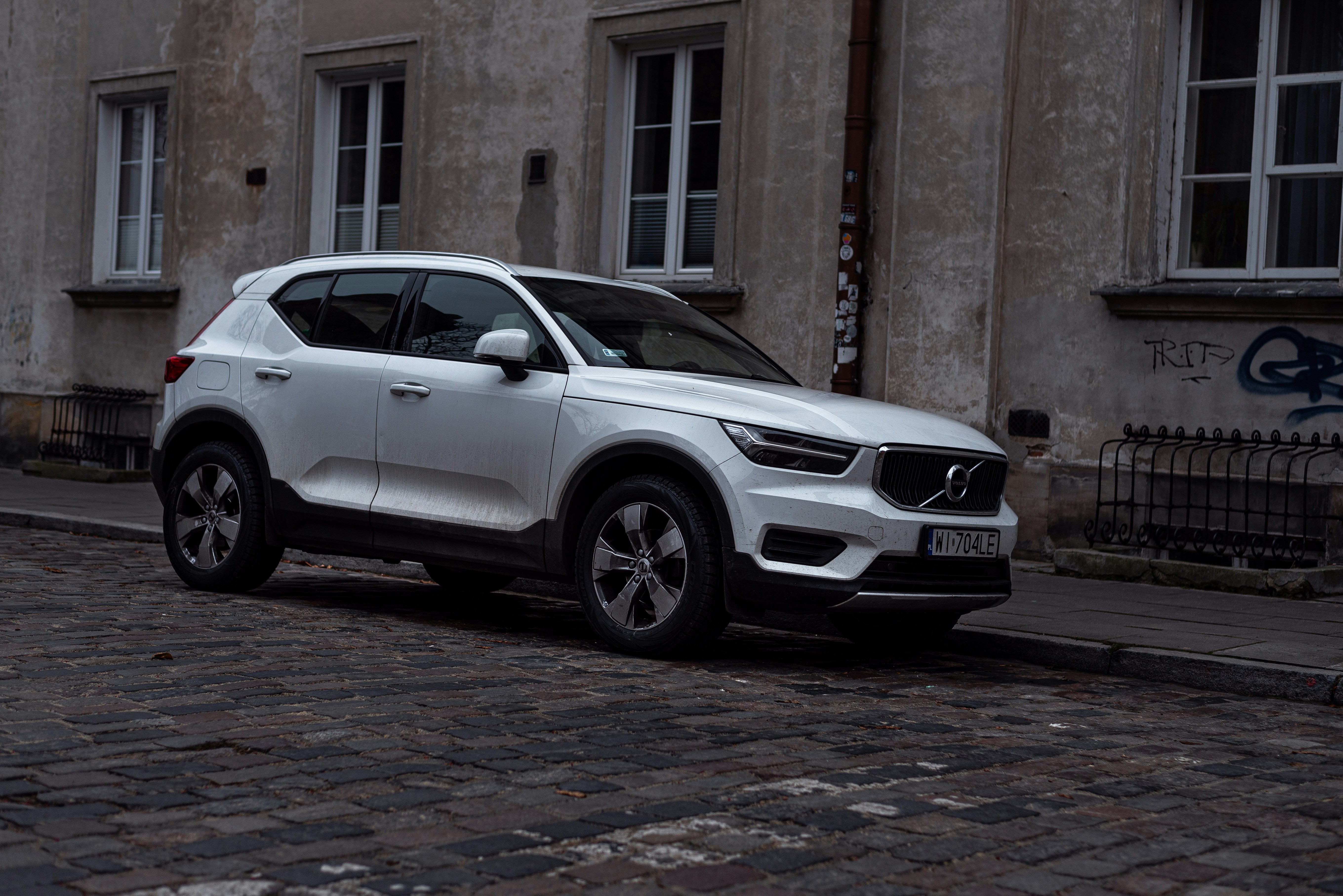 A white volvo car parked on a cobblestone street photo – Free Warsaw ...