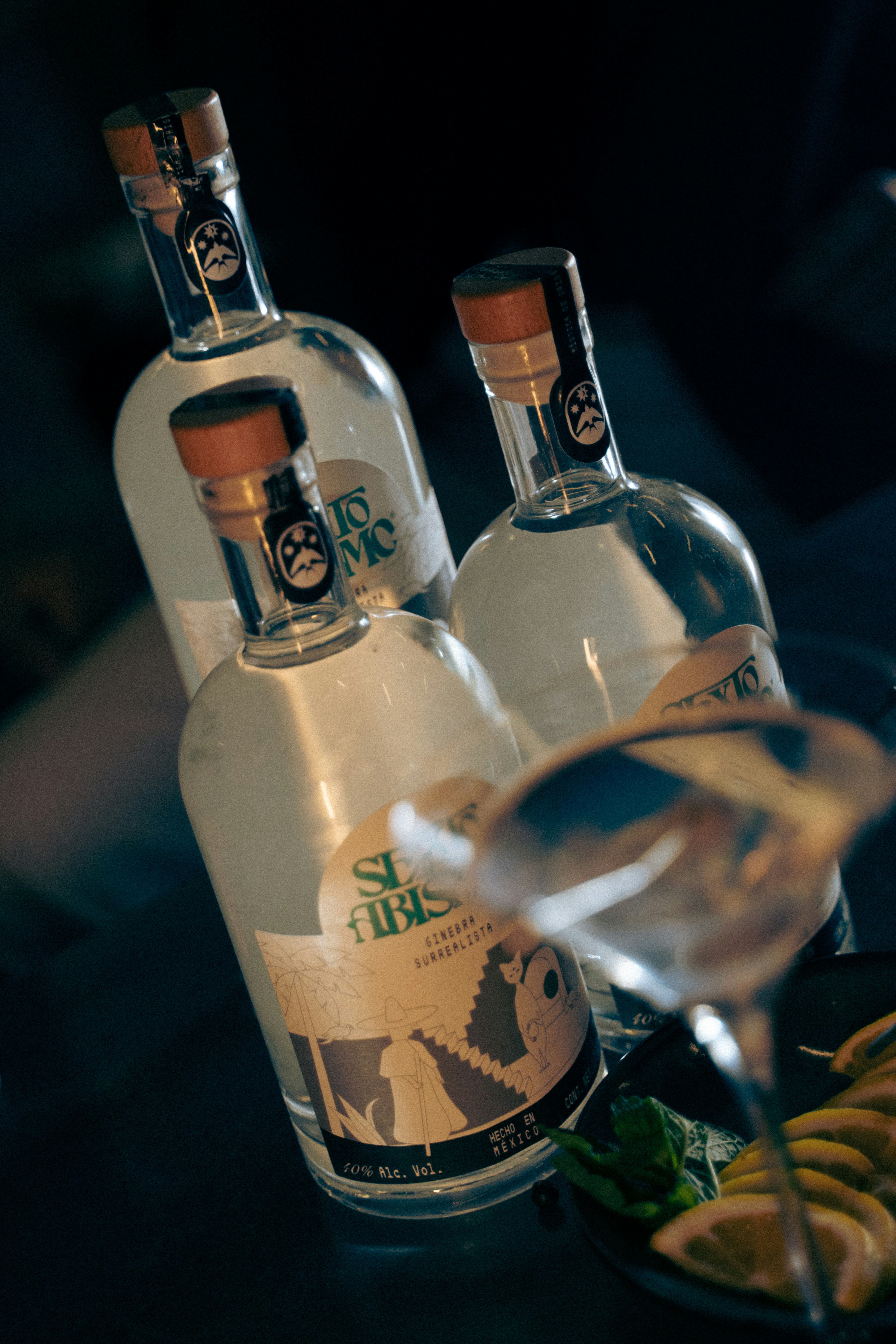 A couple of bottles of alcohol sitting on top of a table photo – Free ...