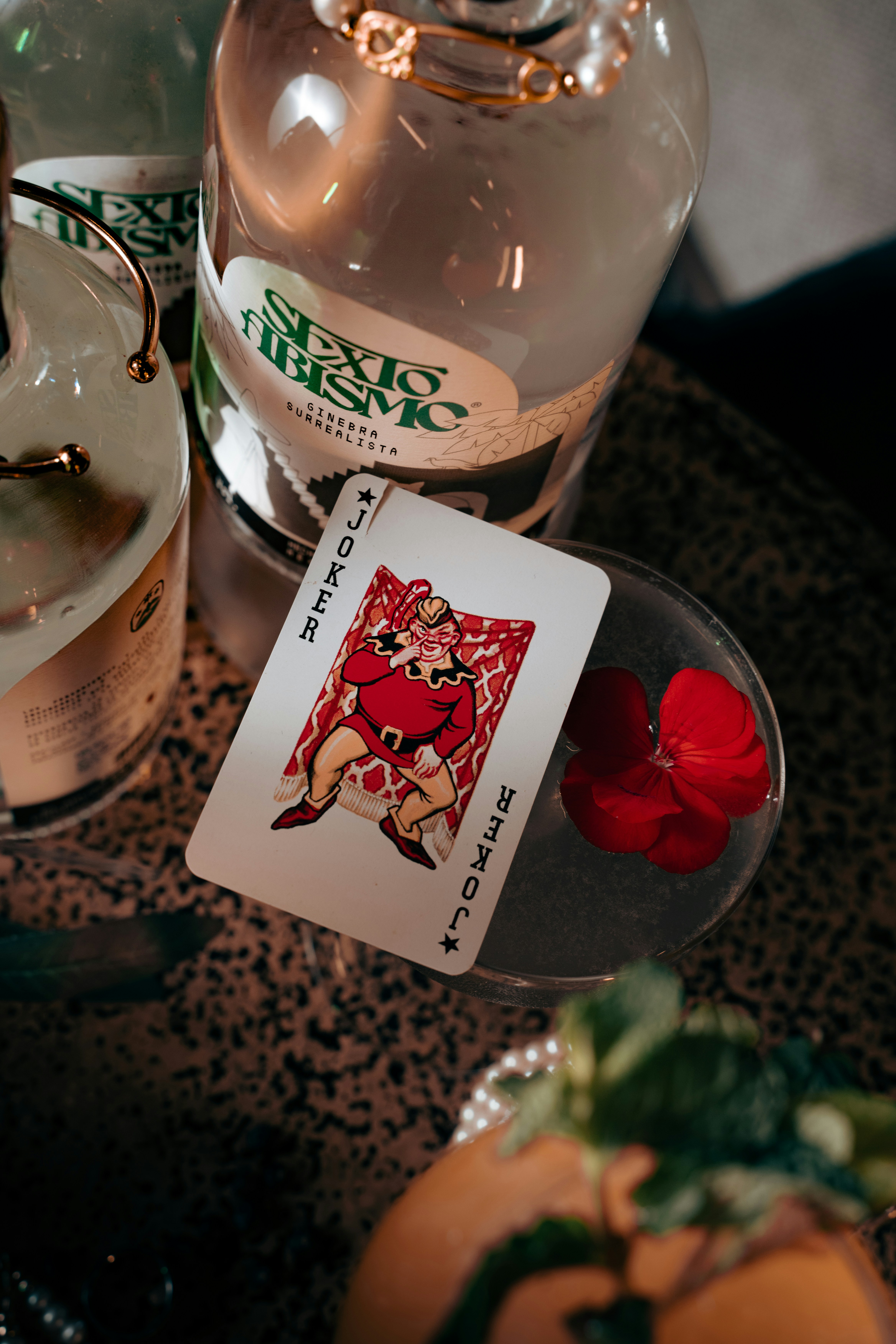 a card sitting on top of a table next to a bottle of alcohol
