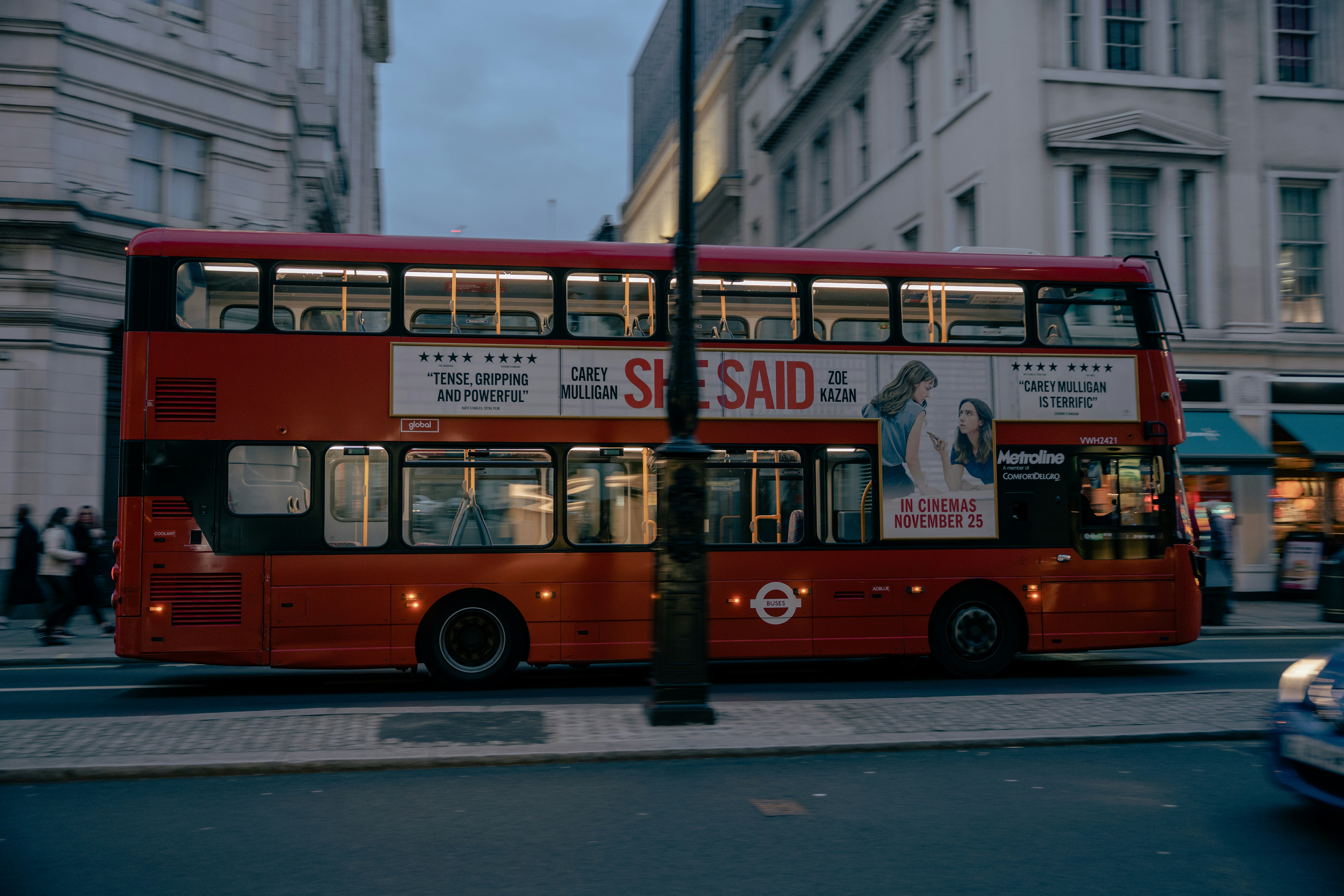 A red double decker bus driving down a street photo – Free London Image ...