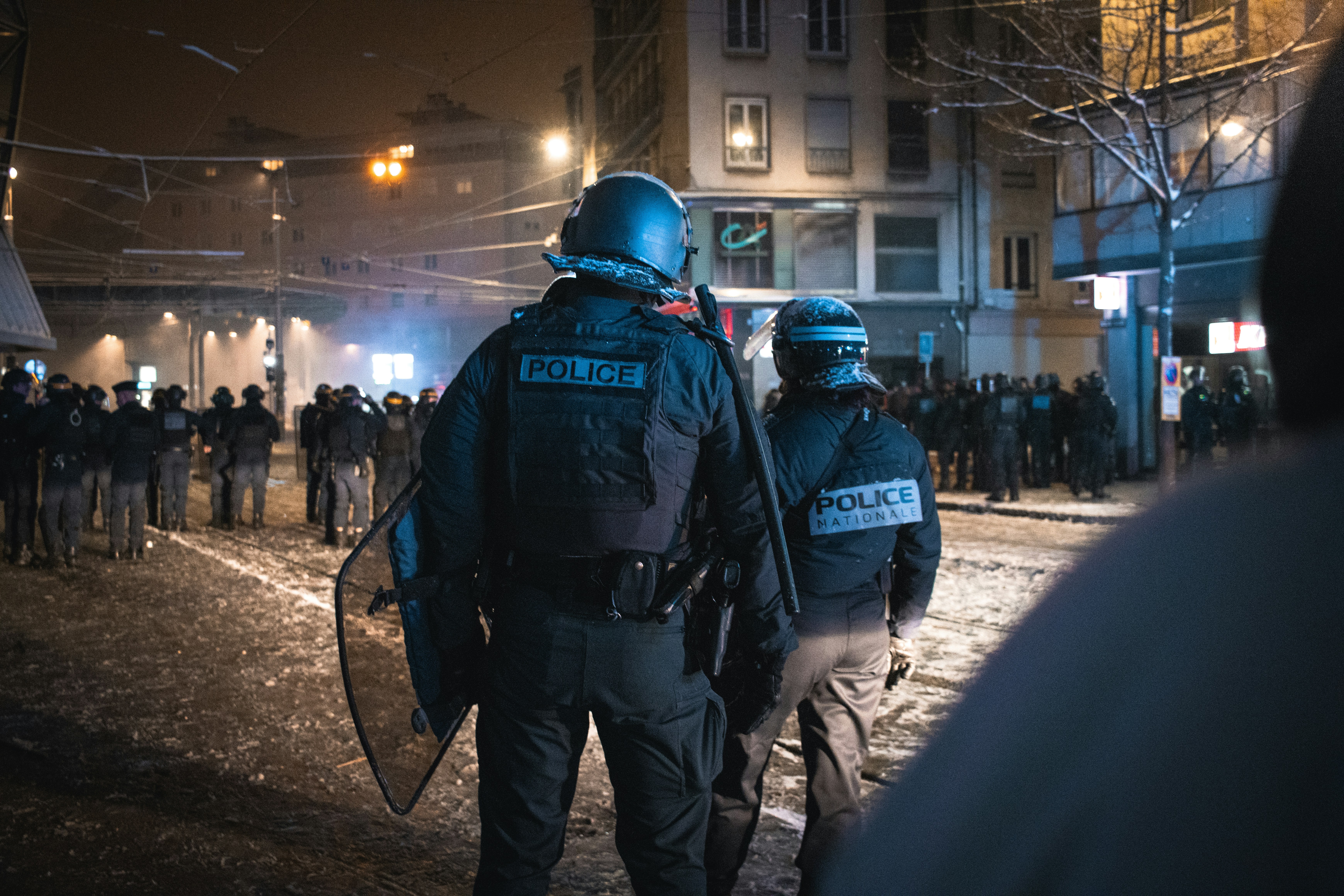 A group of police officers walking down a street photo – Free Police ...