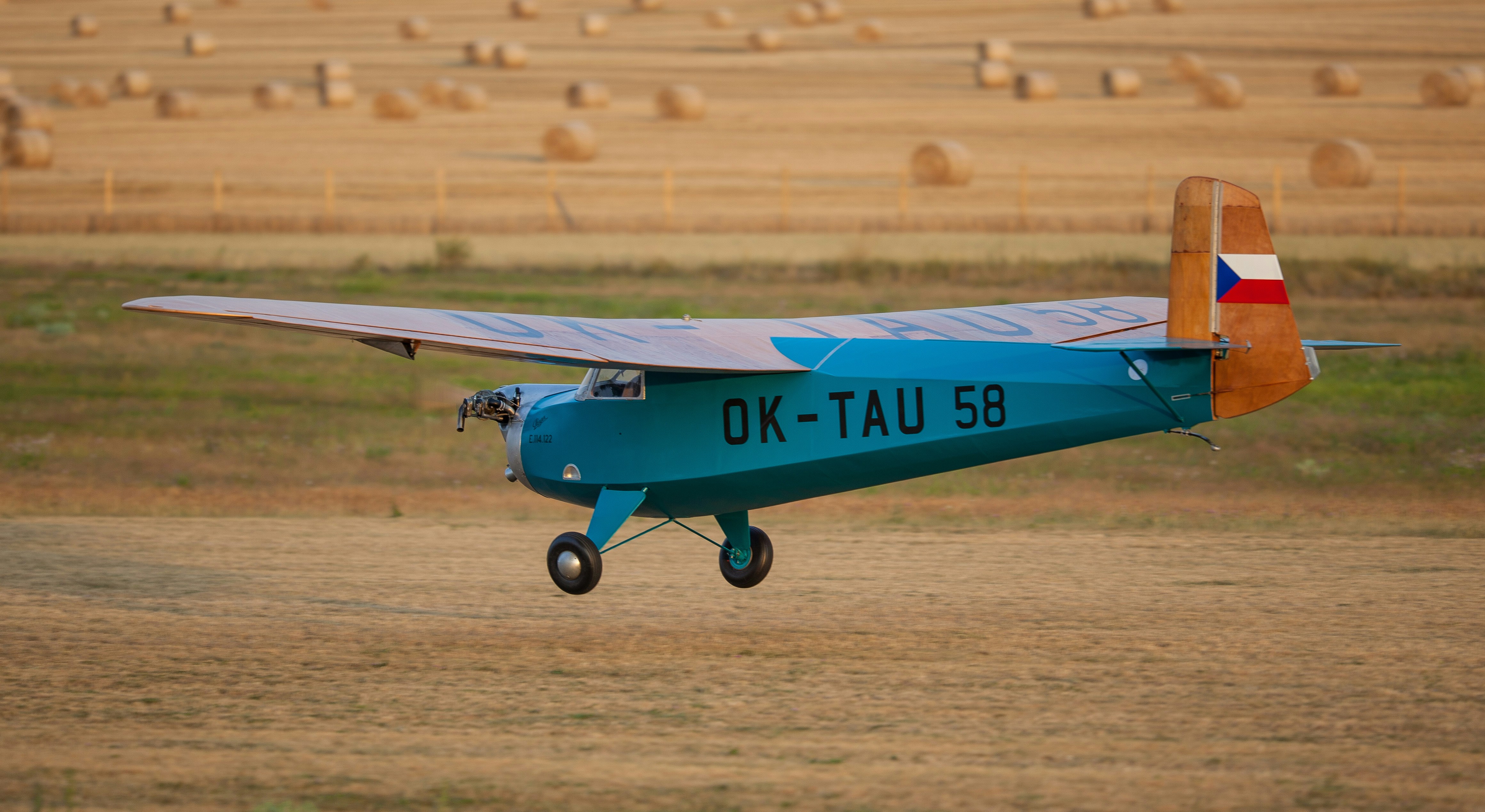 A small blue airplane is flying low to the ground photo – Free Vintage ...