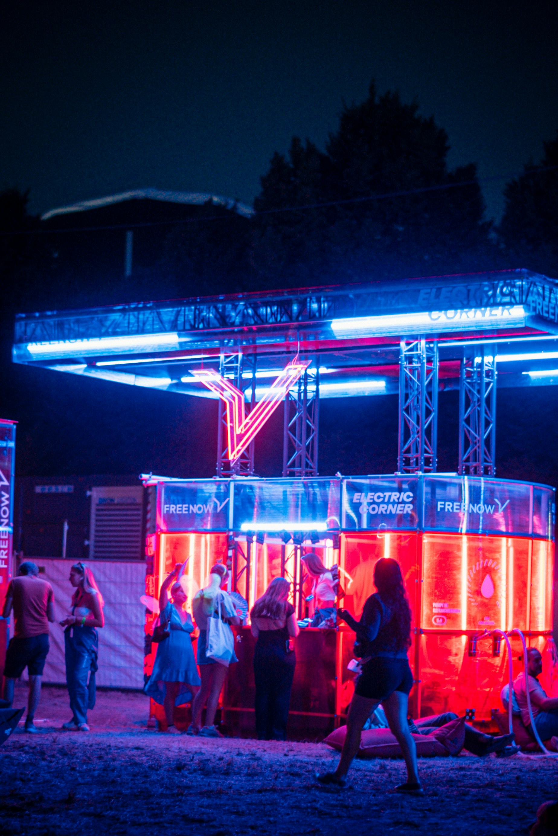 A group of people standing around a stage at night photo – Free Image ...