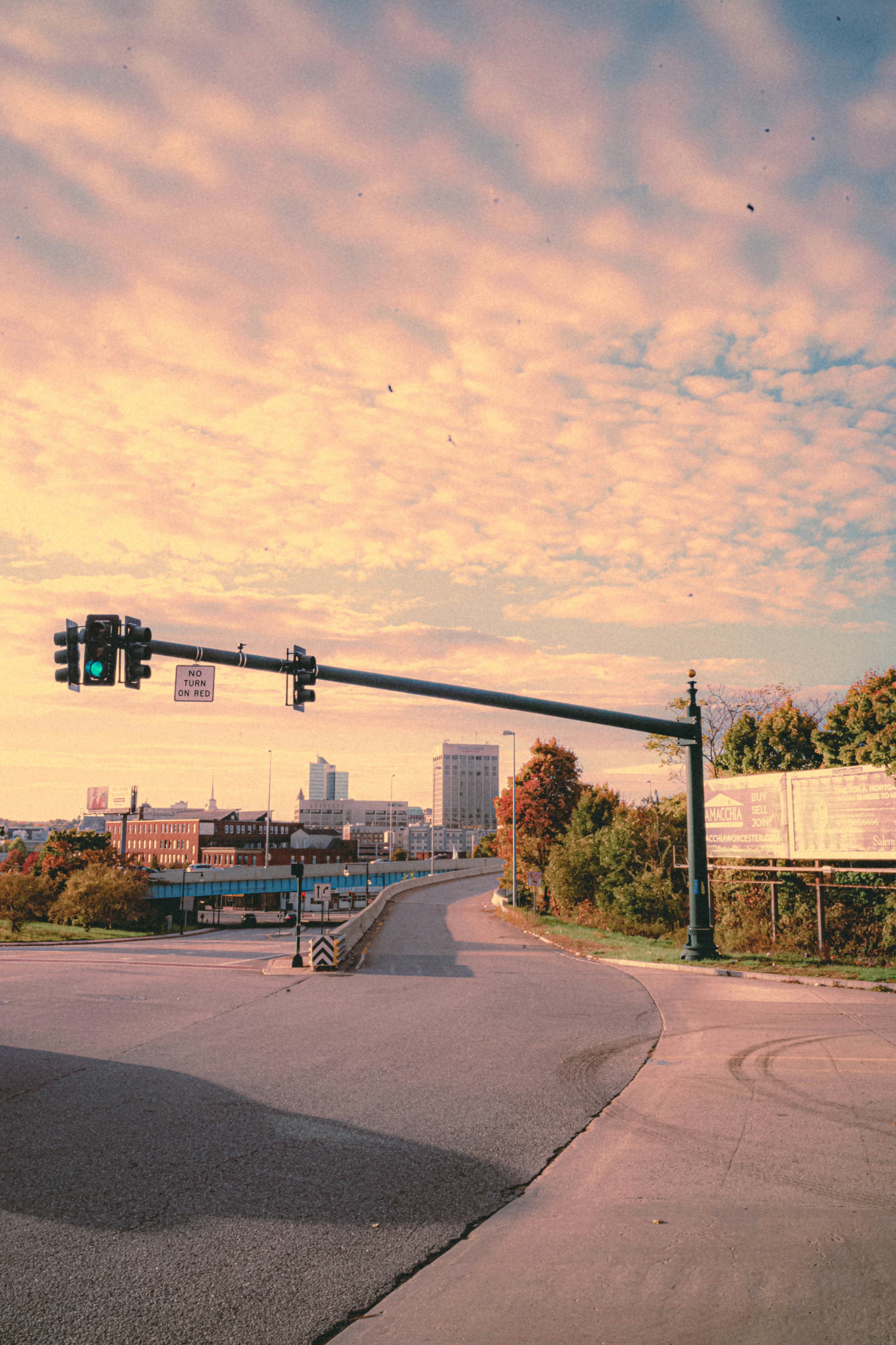 A traffic light hanging over a street next to a parking lot photo ...