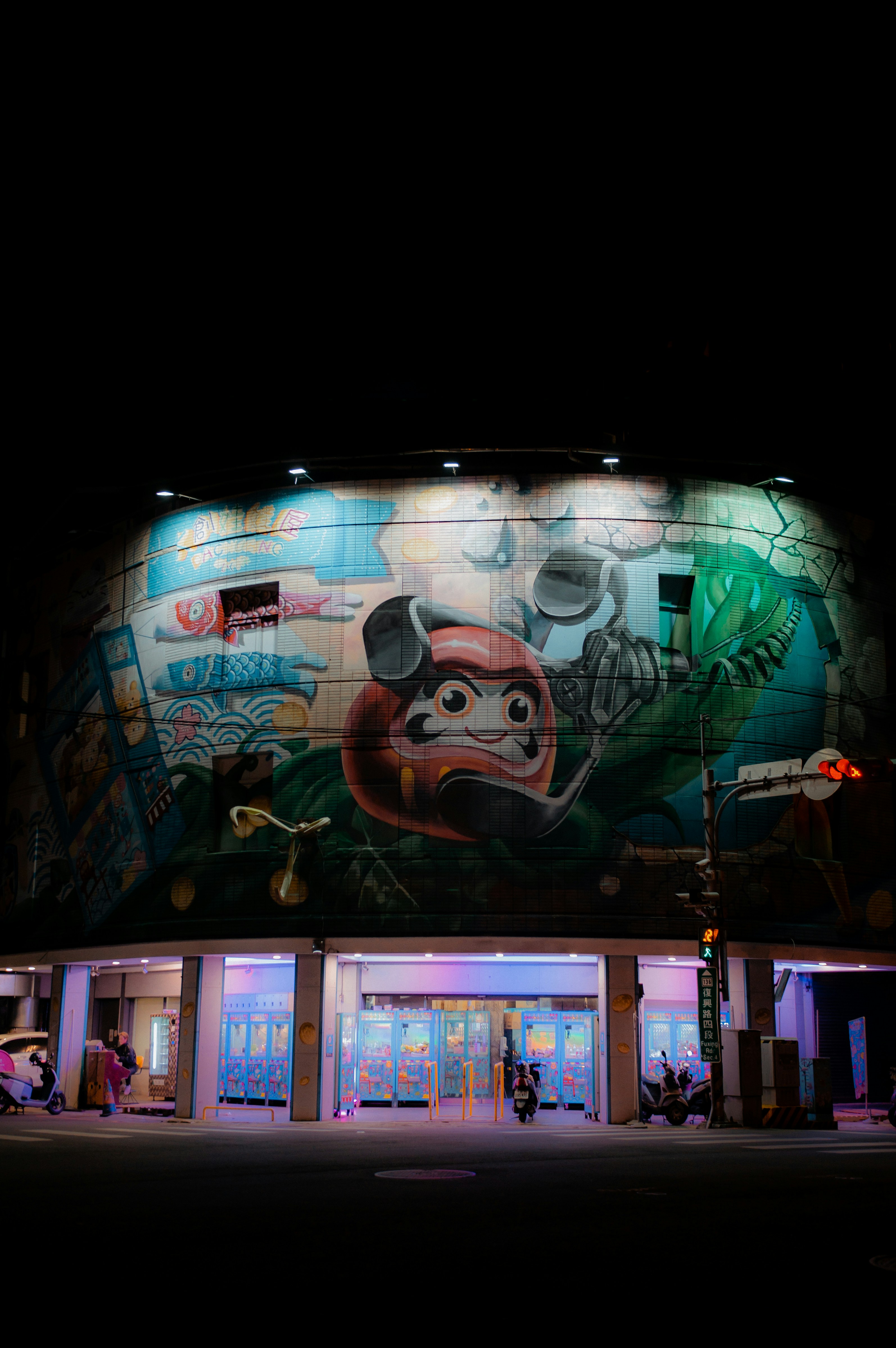 Crimson Cartoon Orb Illuminates a Neon City Facade at Night