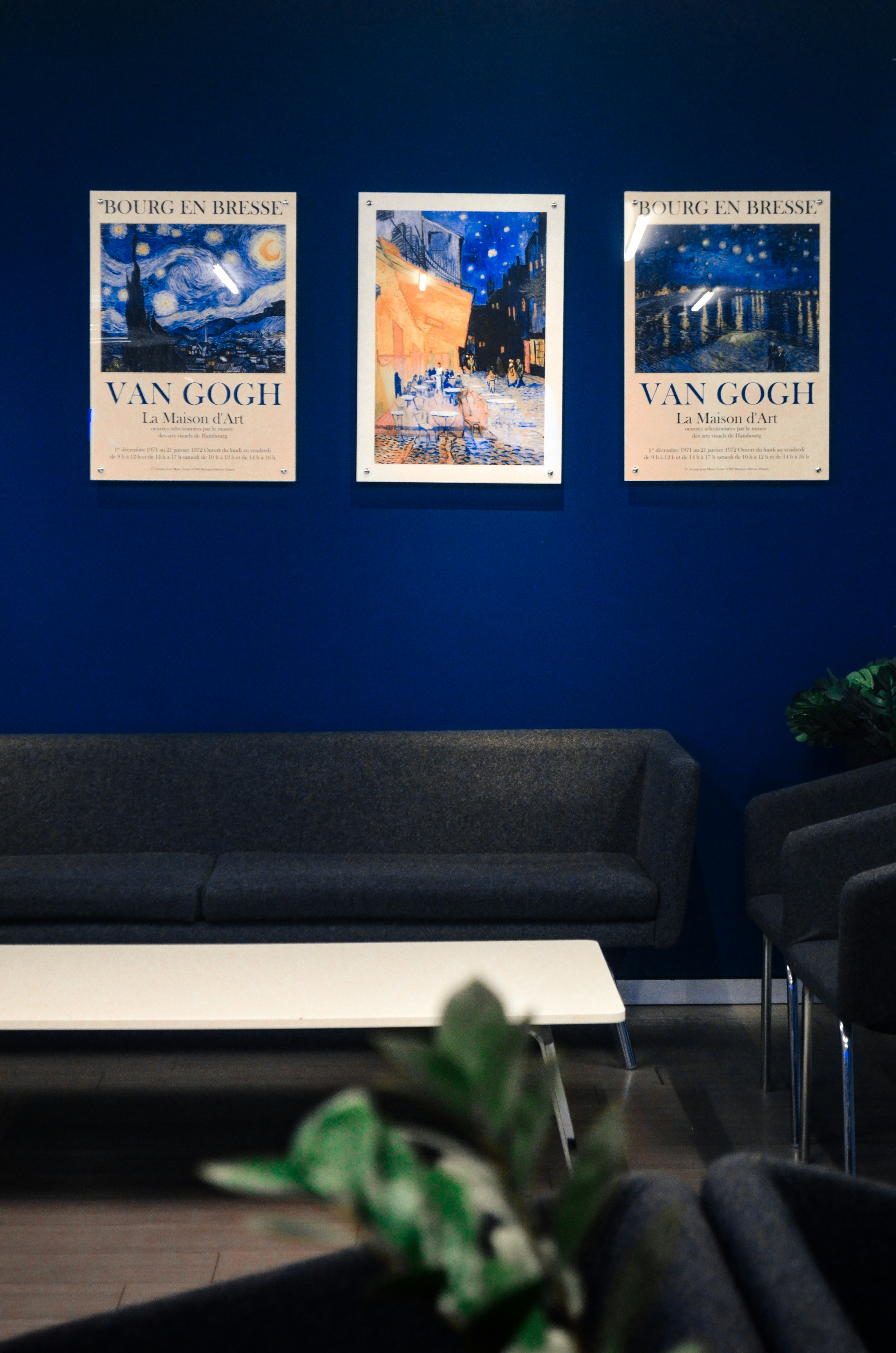 A living room with blue walls and posters on the wall photo – Free ...