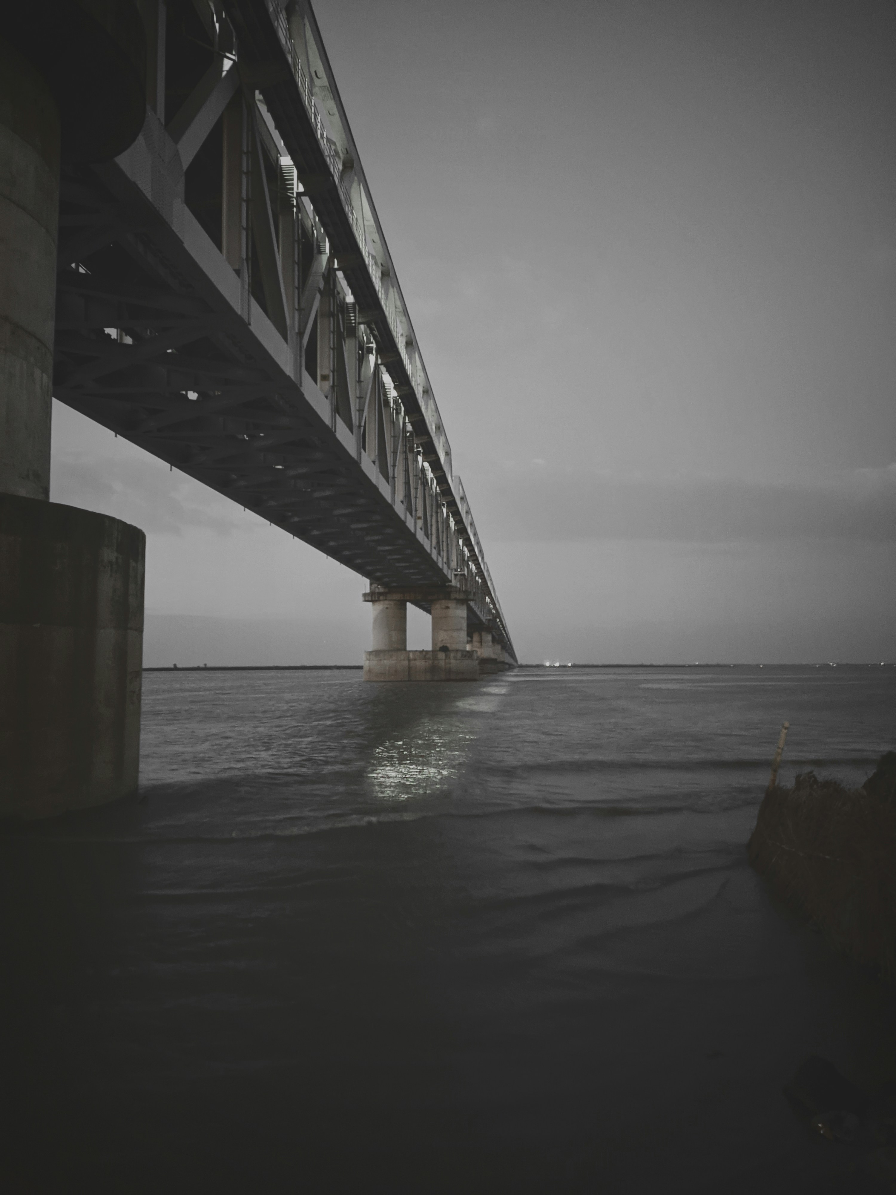 A large bridge spanning over a body of water photo – Free India Image ...