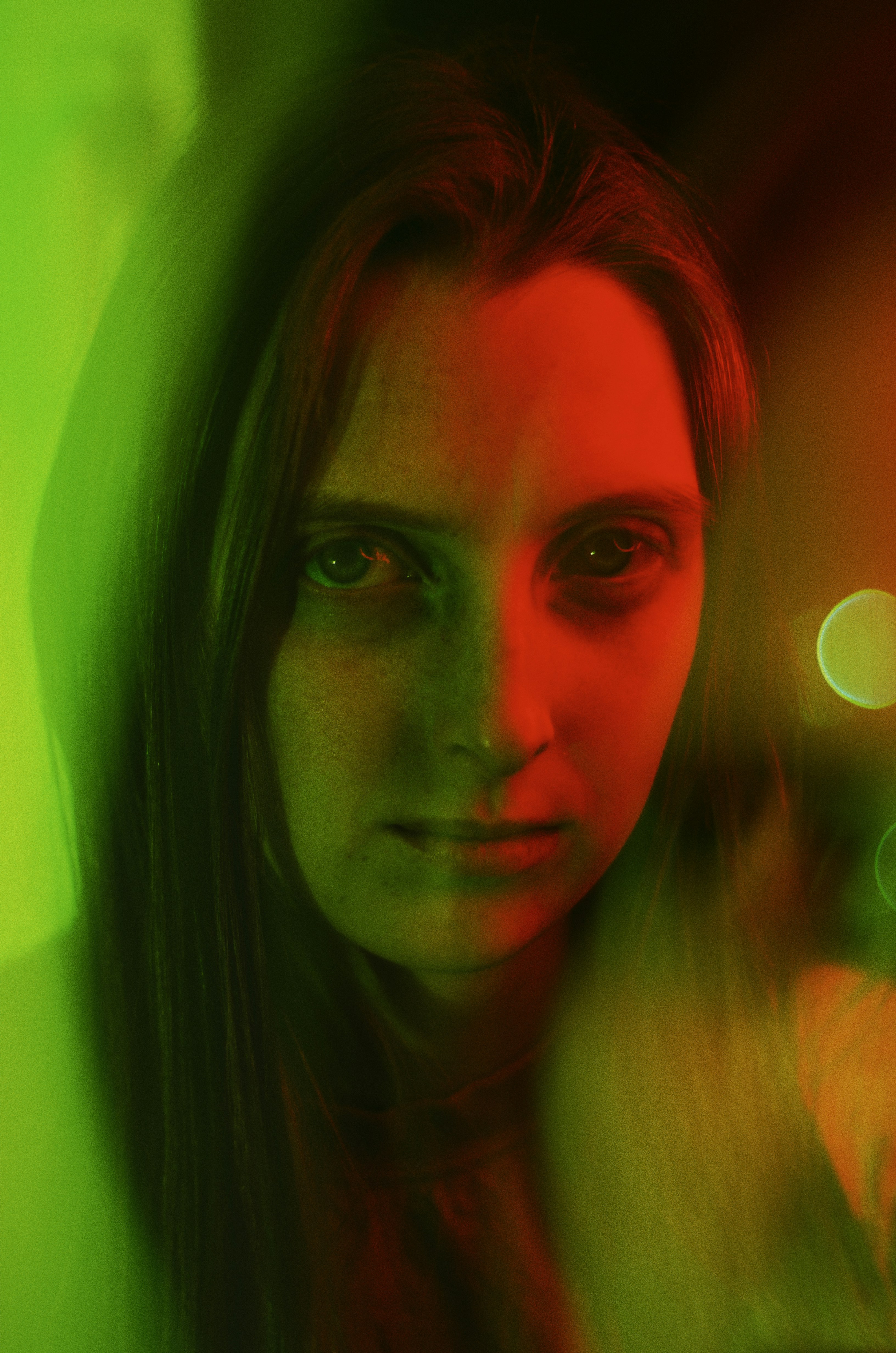 Crimson-Green Gaze: A Portrait Bathed in Neon Veils