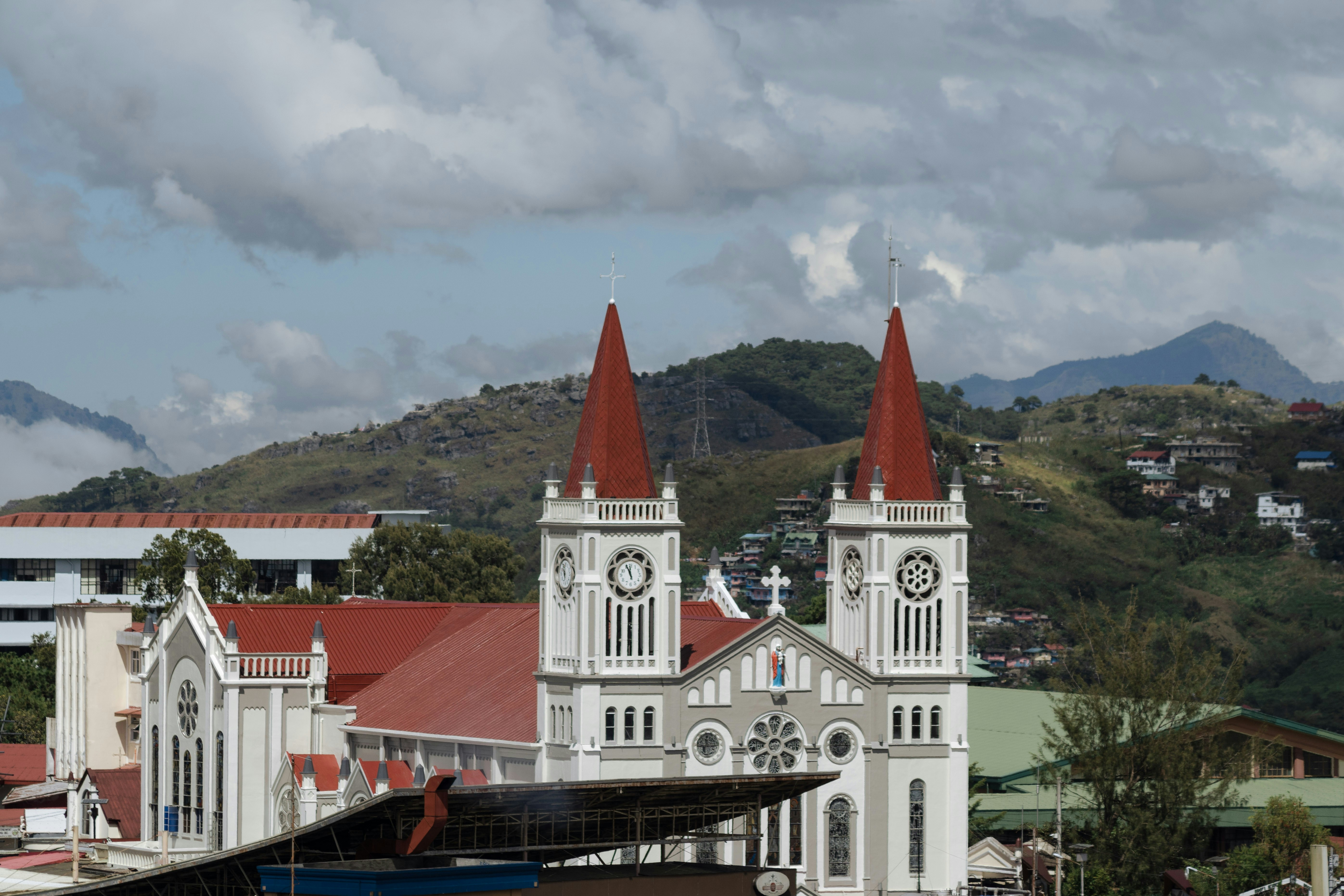 A large white church with red steeples on top of it photo – Free Arch ...