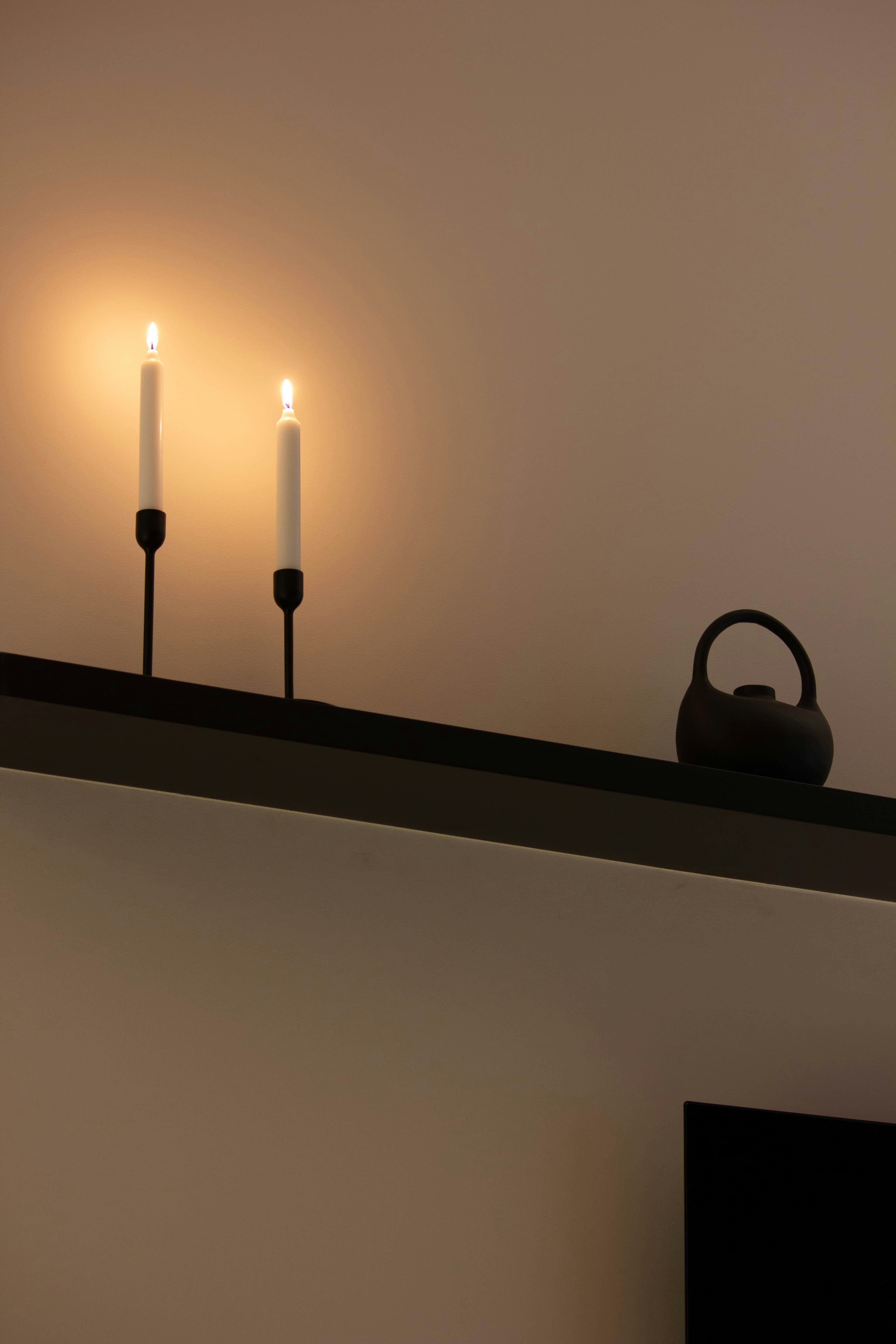 Candlelit Calm: A Minimal Shelf Scene with a Kettle