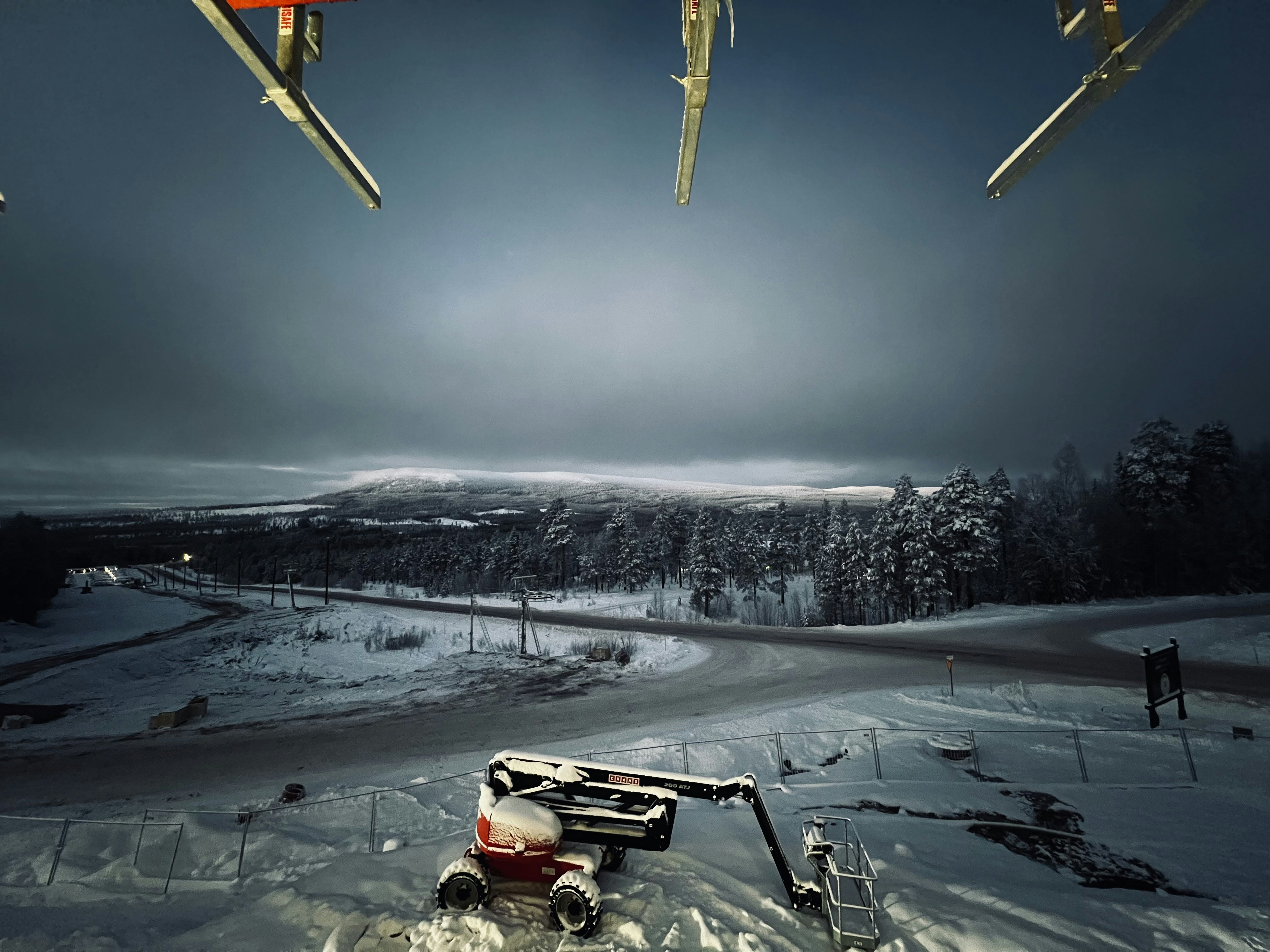 Red Crawler Crane on a Moonlit Snowfield
