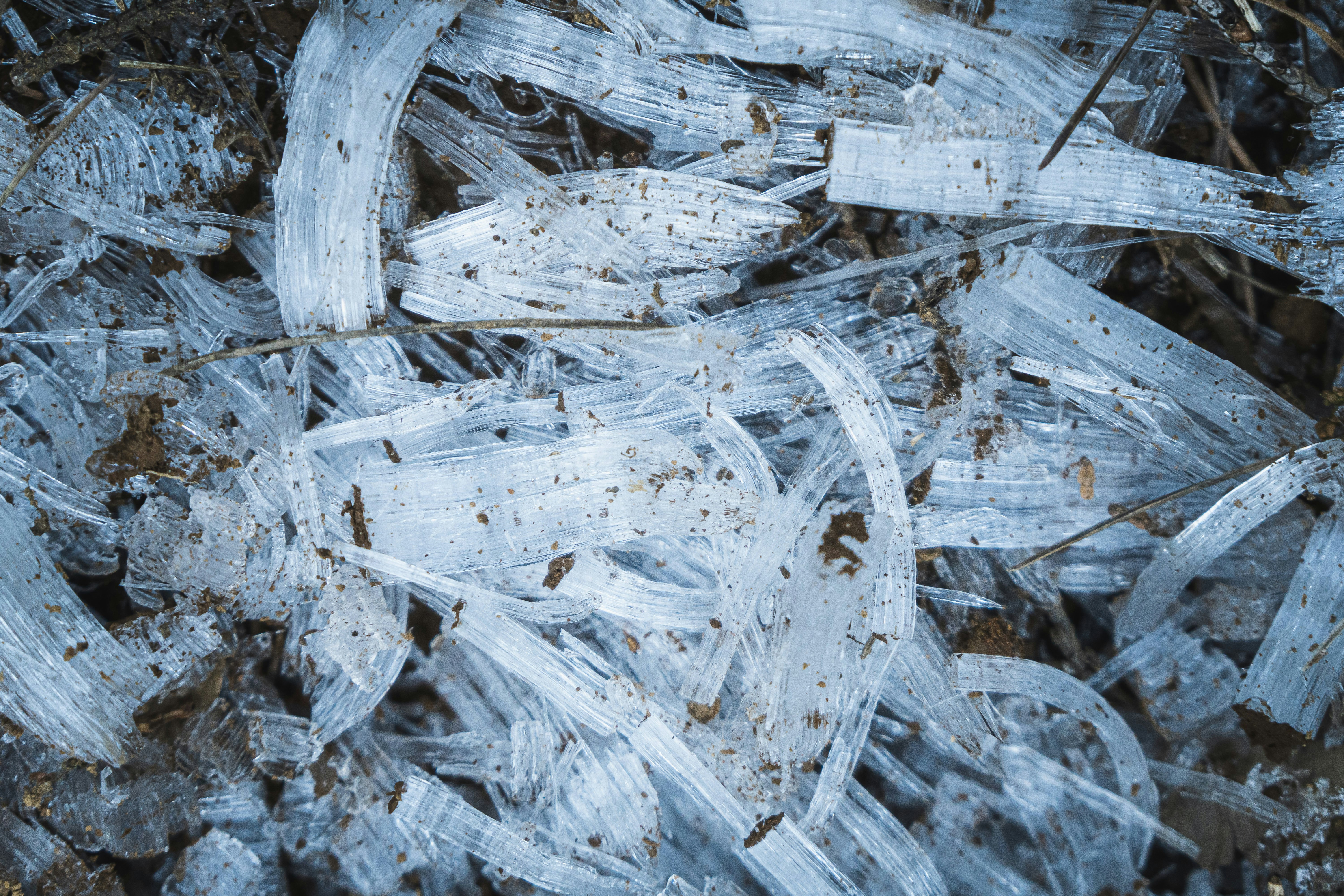 A bunch of ice crystals sitting on the ground photo – Free Ice Image on ...