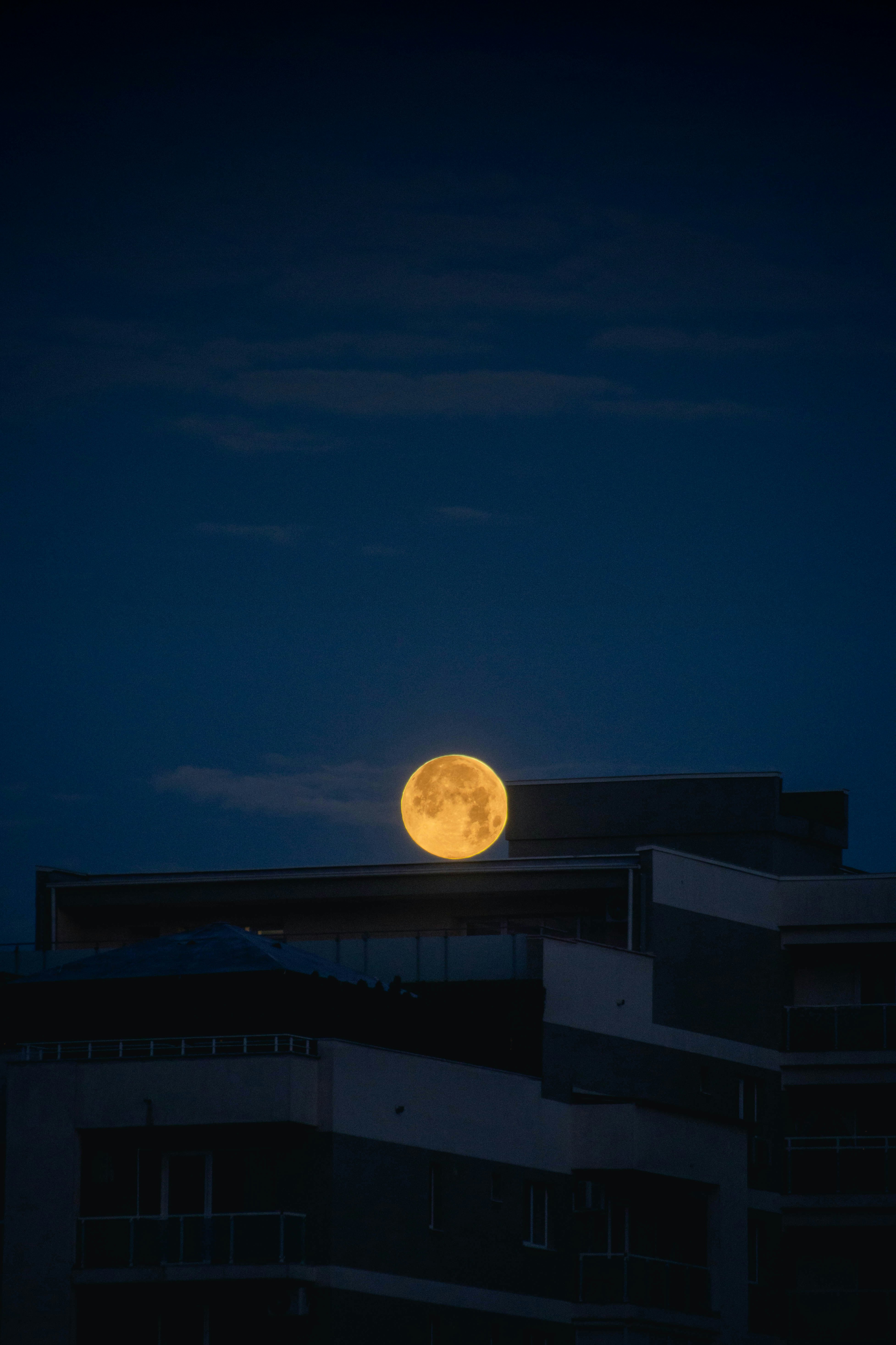 A full moon is seen over a building photo – Free Astronomy Image on ...