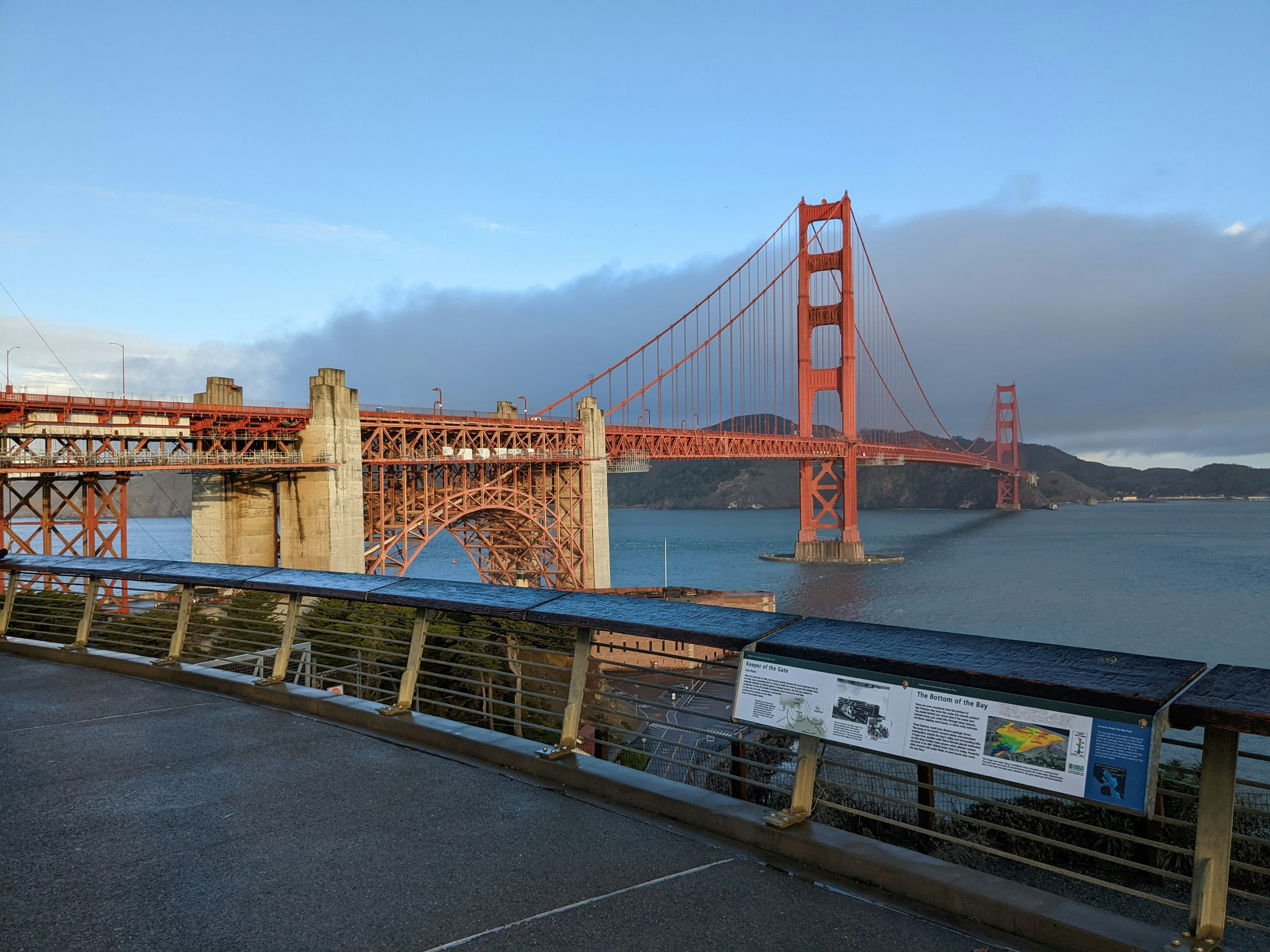 Crissy Field Overlook: The Golden Gate's Red Sentinels Framed by Waterfront Rail