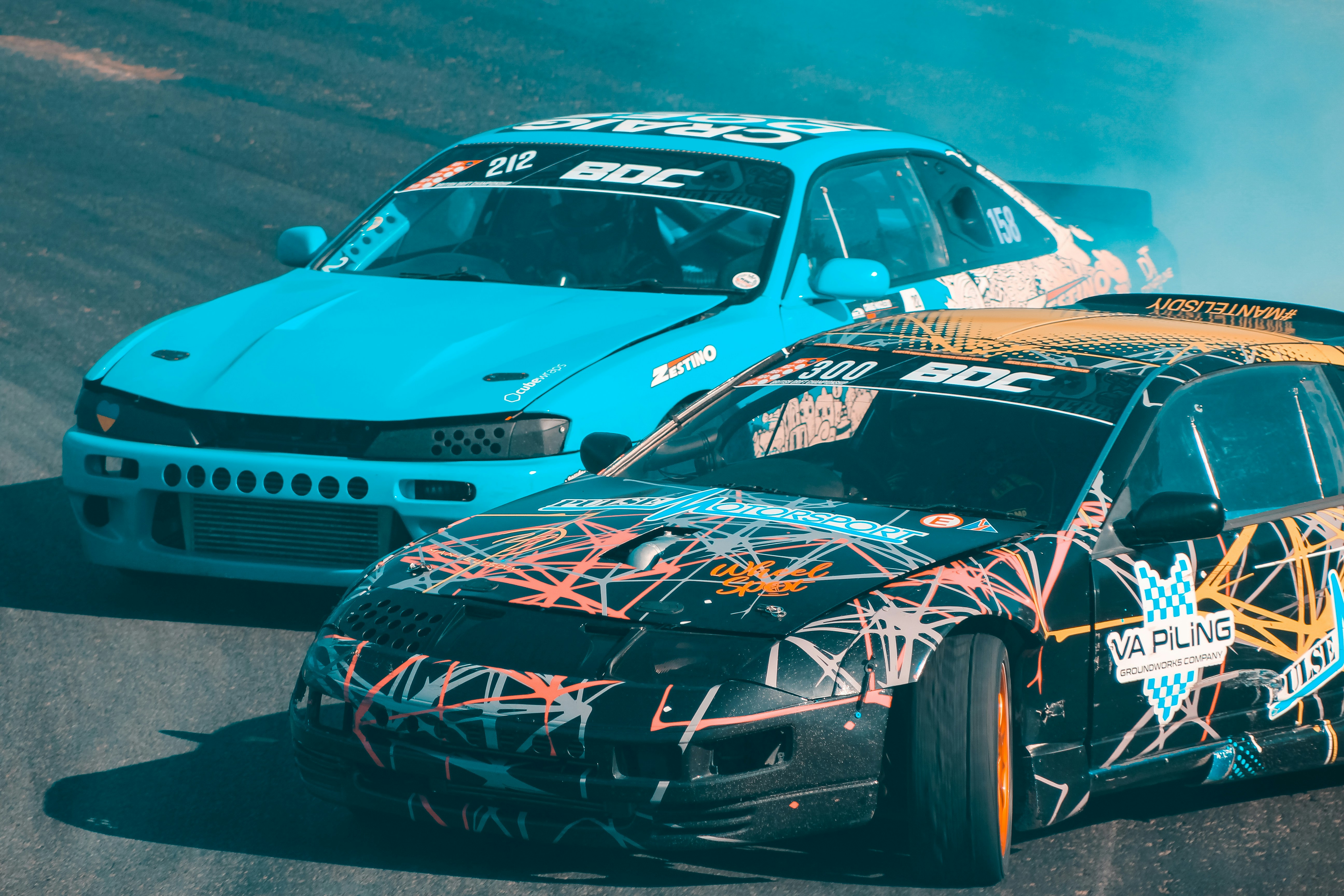 A couple of cars that are on a race track photo – Free Image on Unsplash