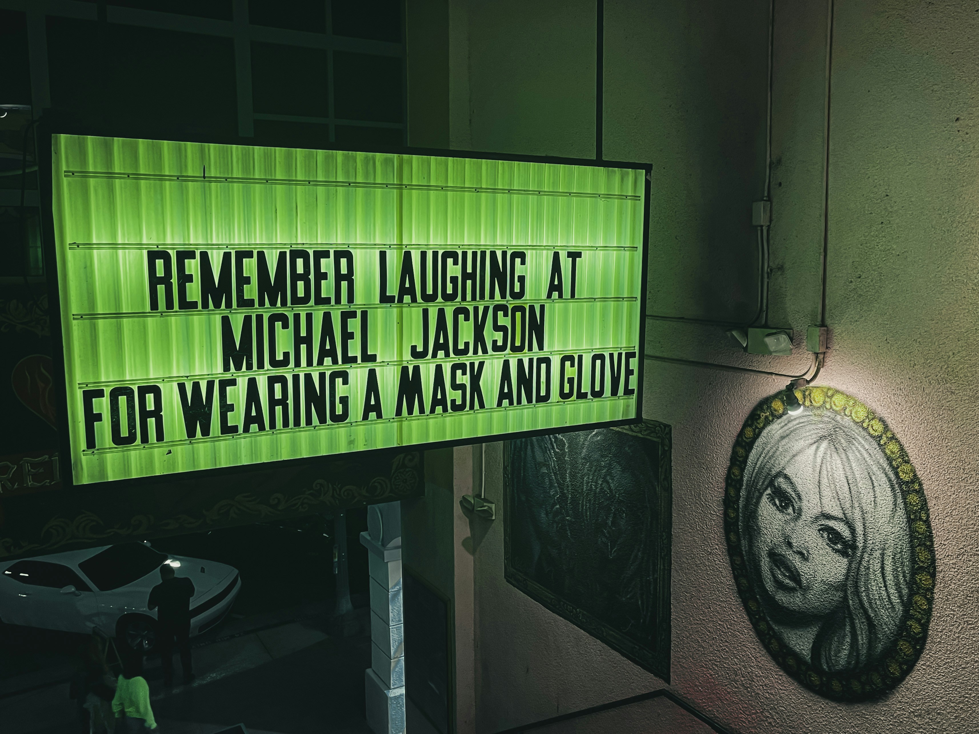 A neon sign that says, remember laughing at michael jackson for wearing ...