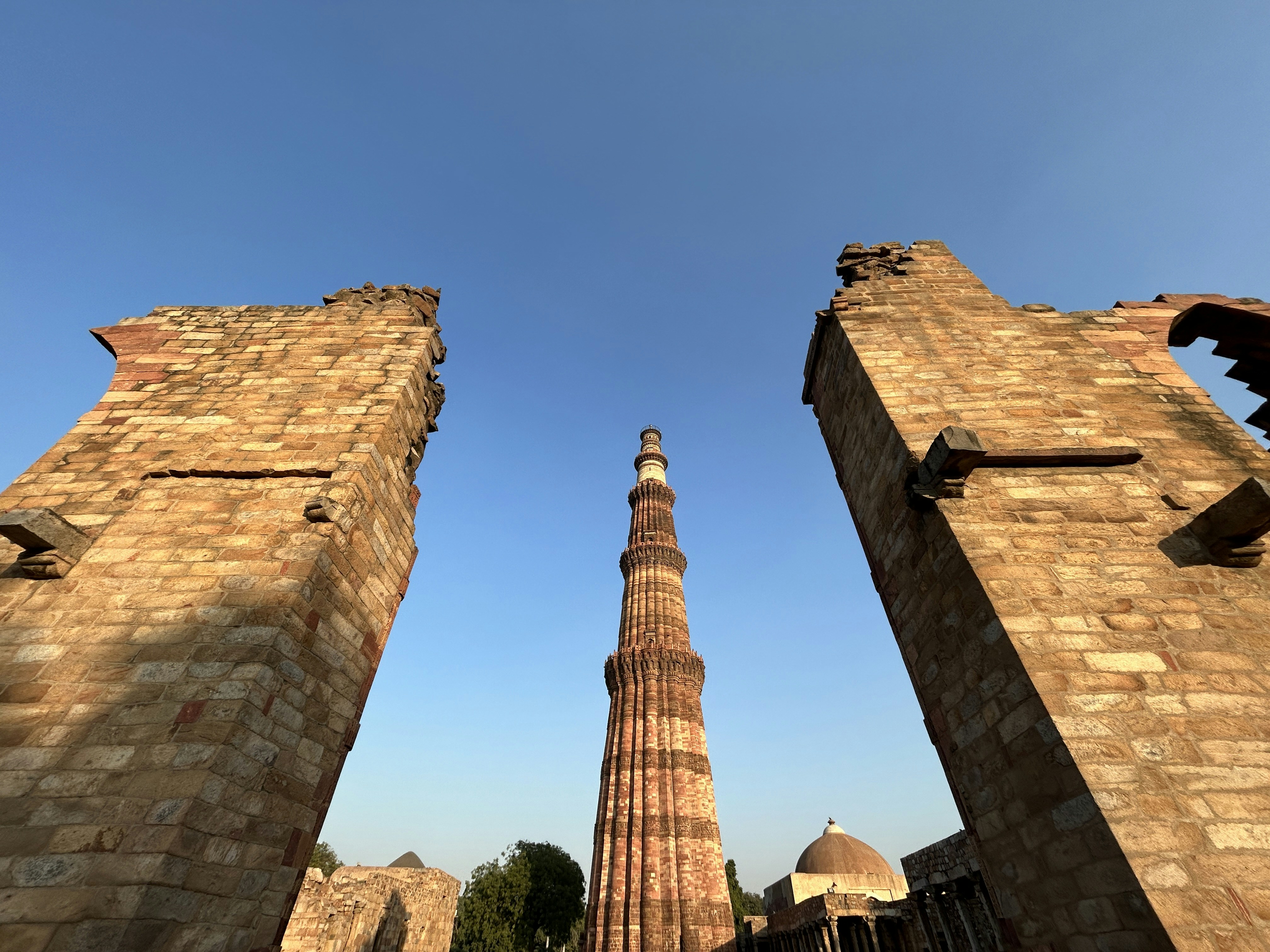 A tall brick tower towering over a city photo – Free Architecture Image ...