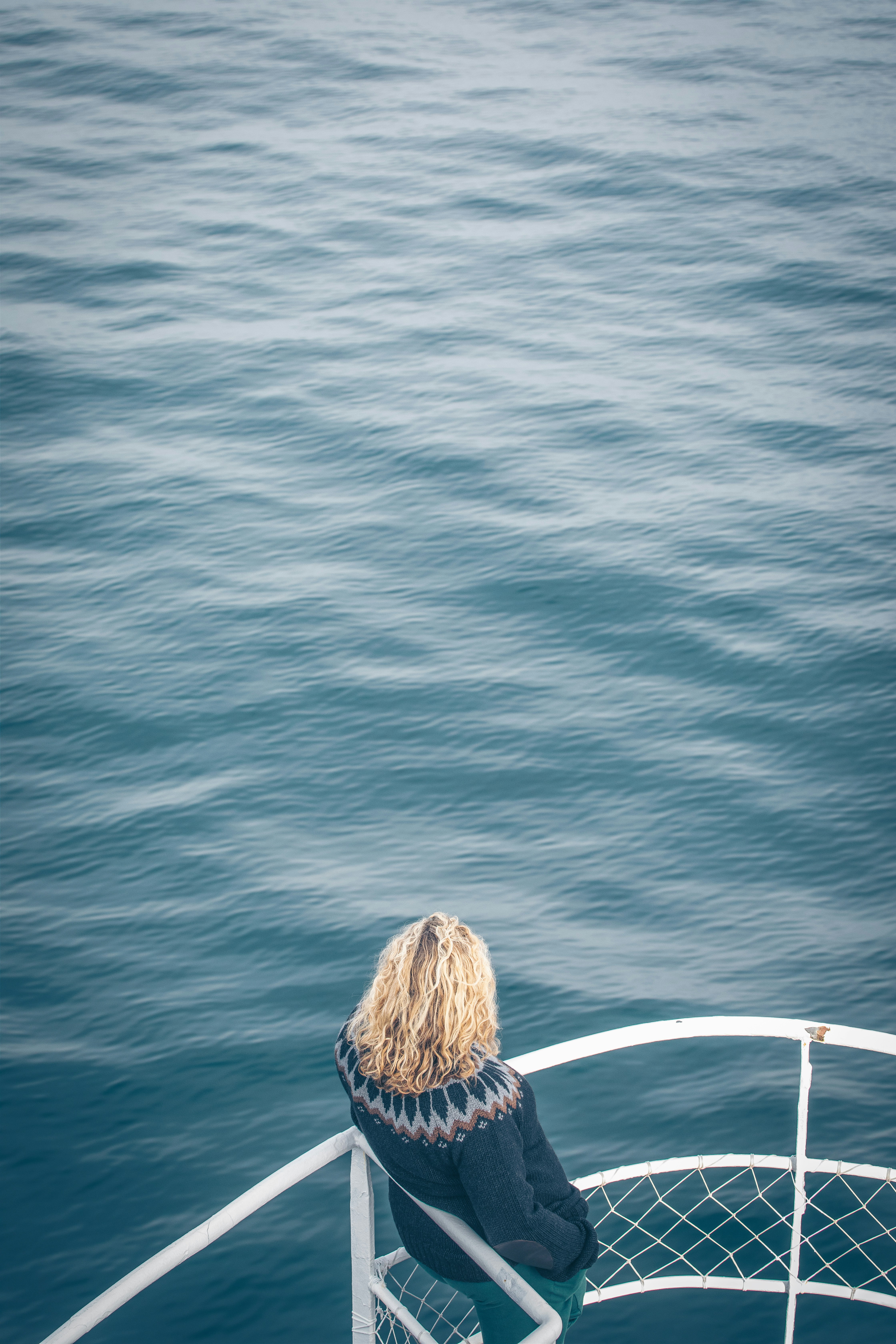 Blue Expanse, Quiet Gaze: A Seafarer's Moment at the Rail