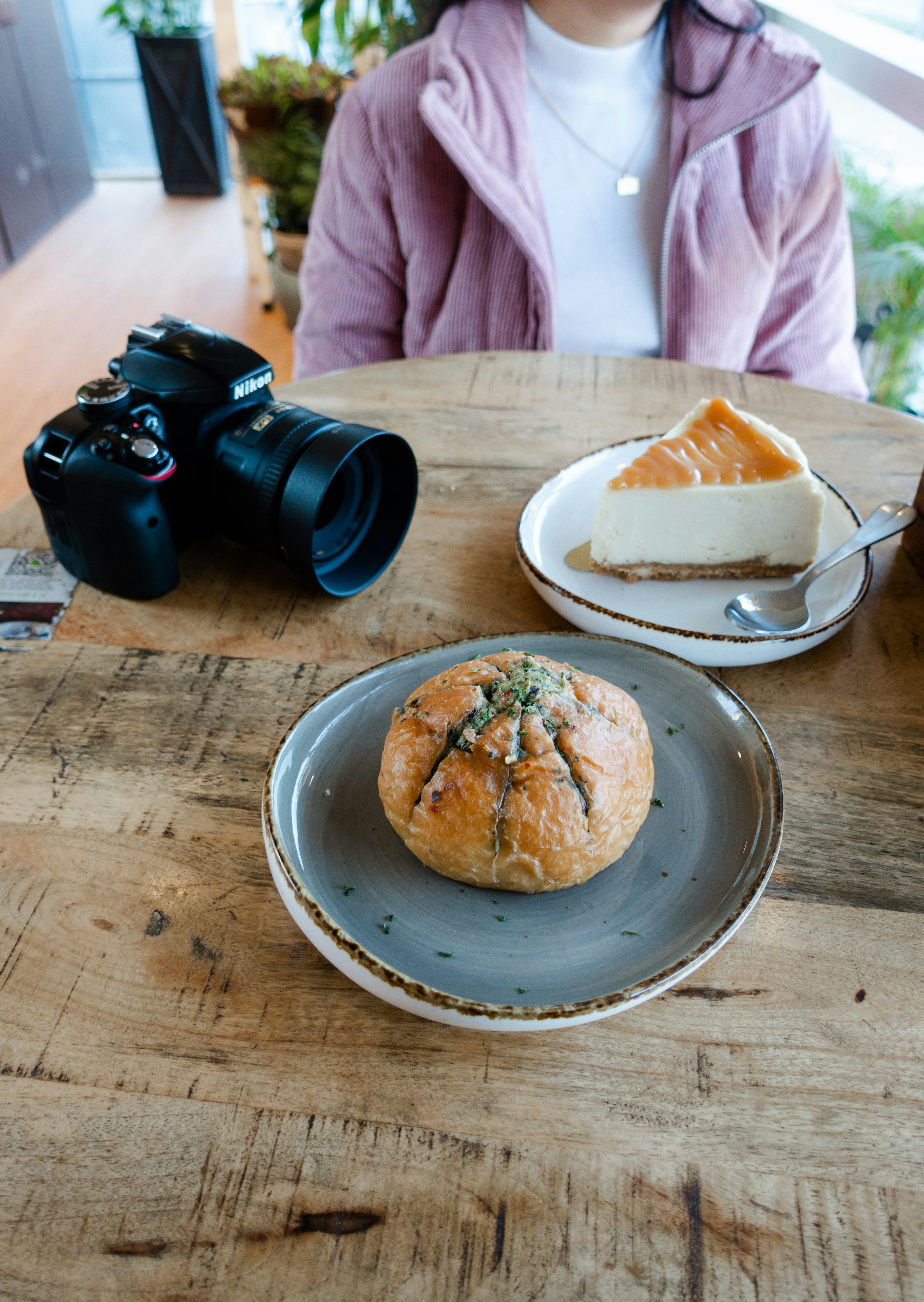 Morning Café Still Life: A Nikon by Pastries on a Weathered Table