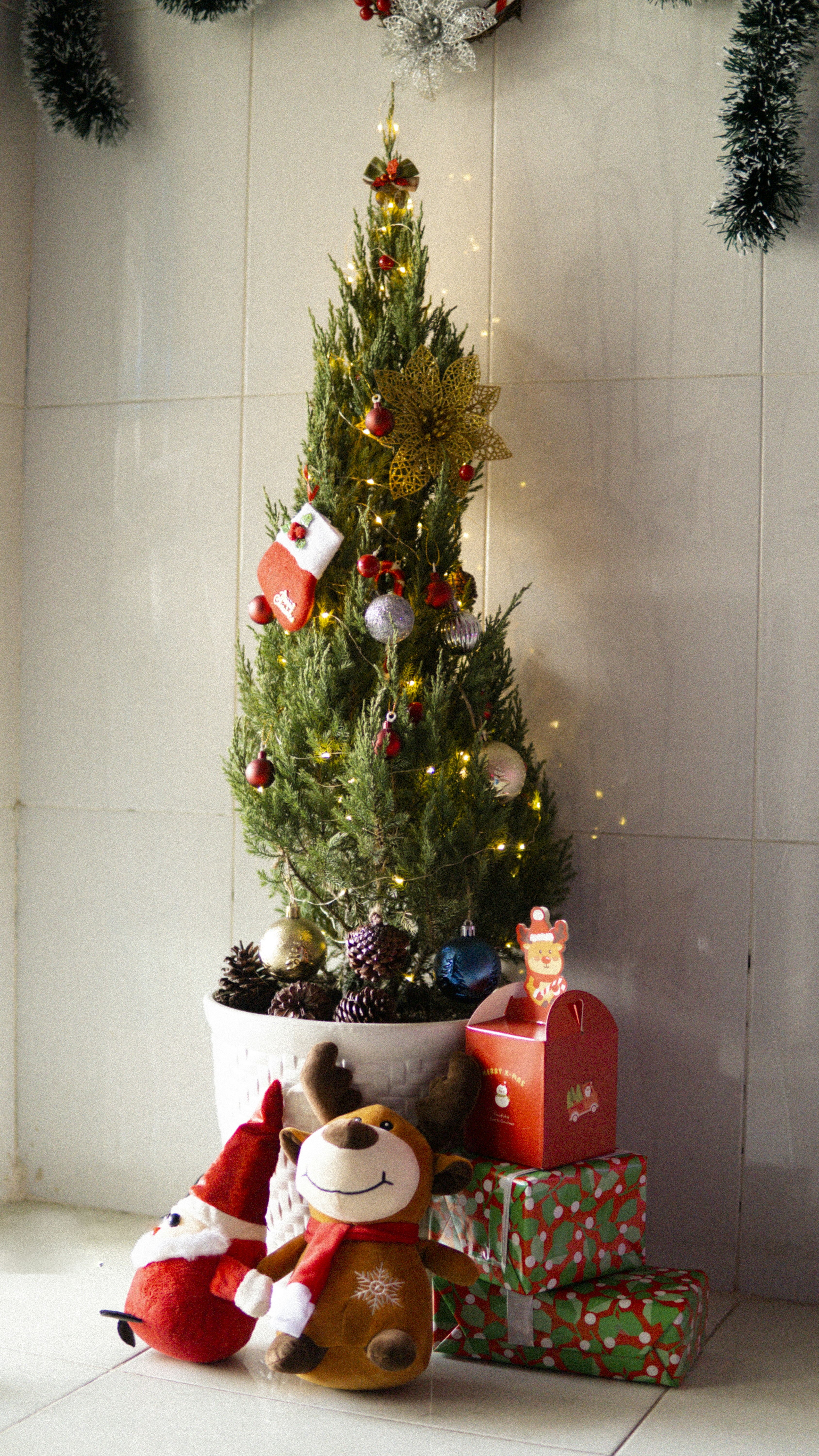 A Festive Miniature Tree with Plush Companions and Gift Parade