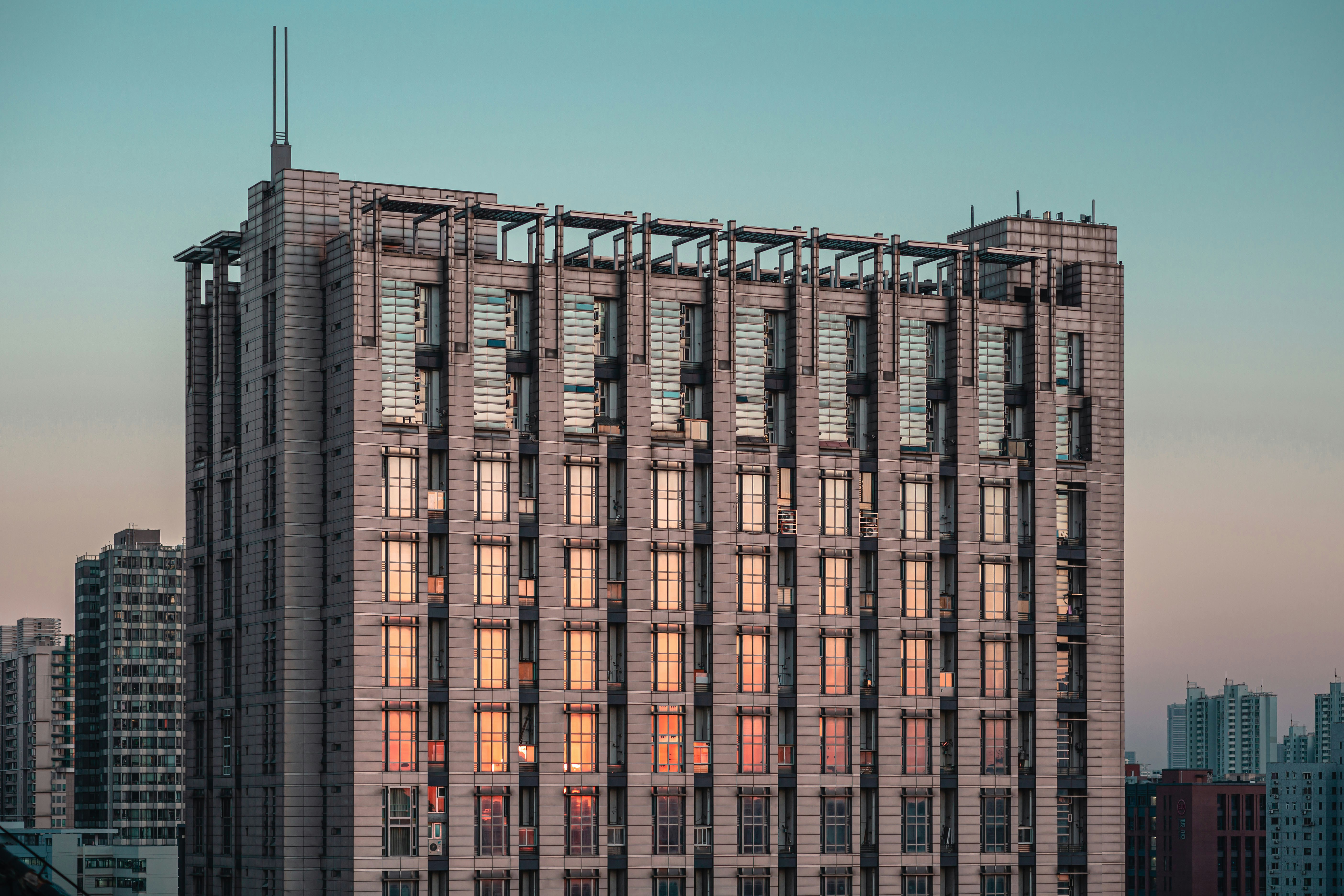 Dusk Grid: The Repeating Facade of a Brick High-Rise