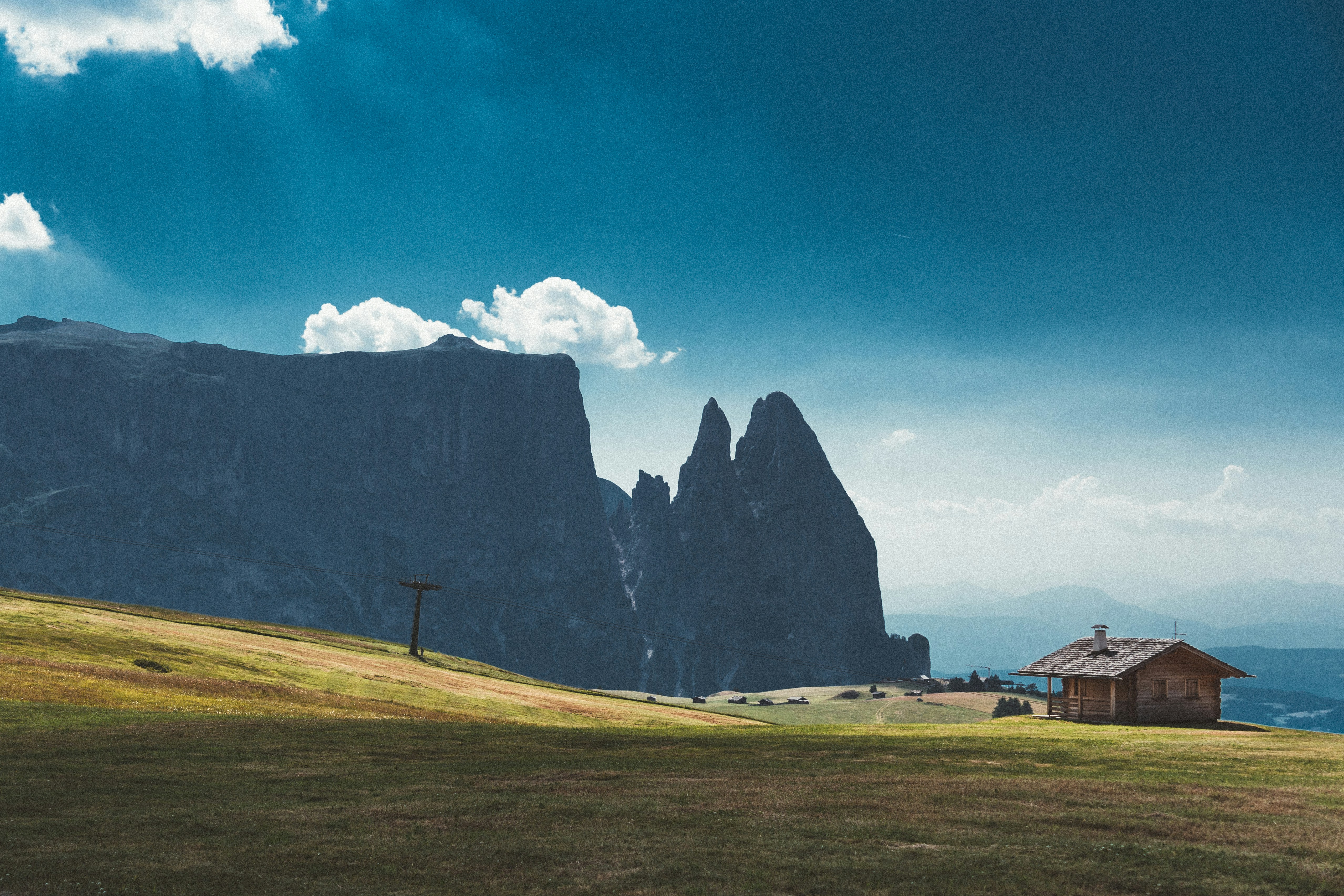 A house on a hill with mountains in the background photo – Free Seiser ...
