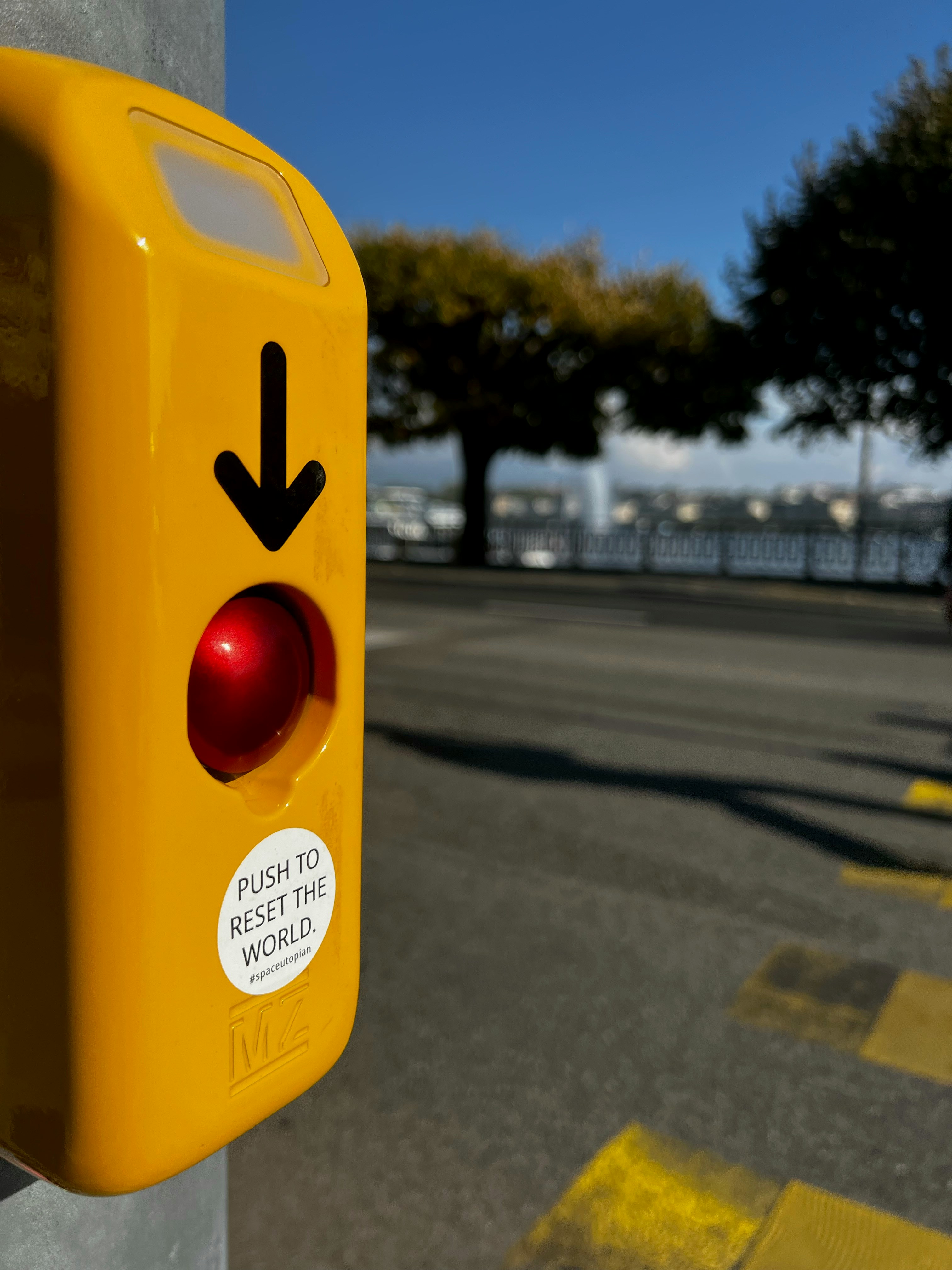 a yellow traffic light sitting on the side of a road
