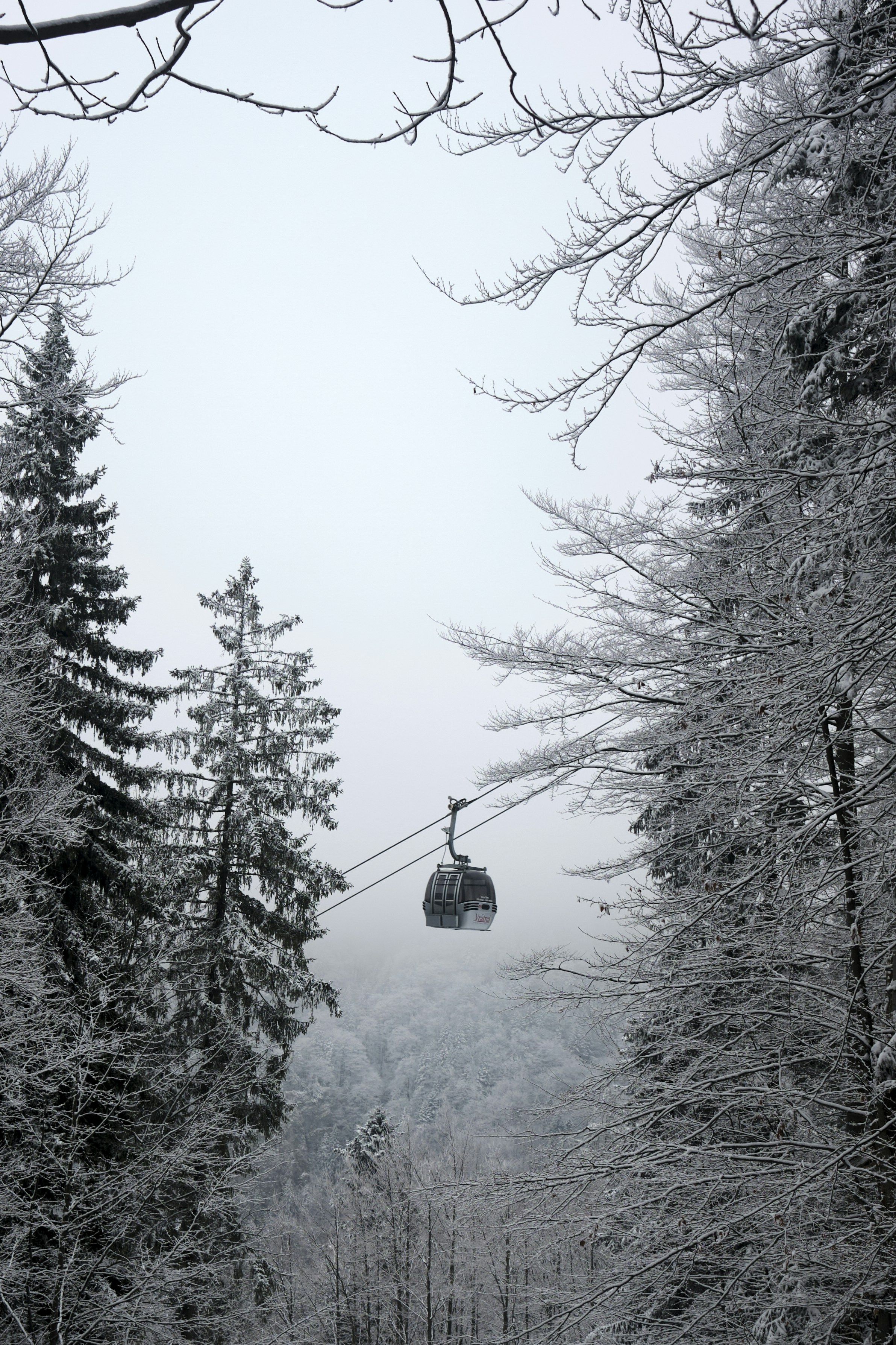 a ski lift going up a snowy mountain