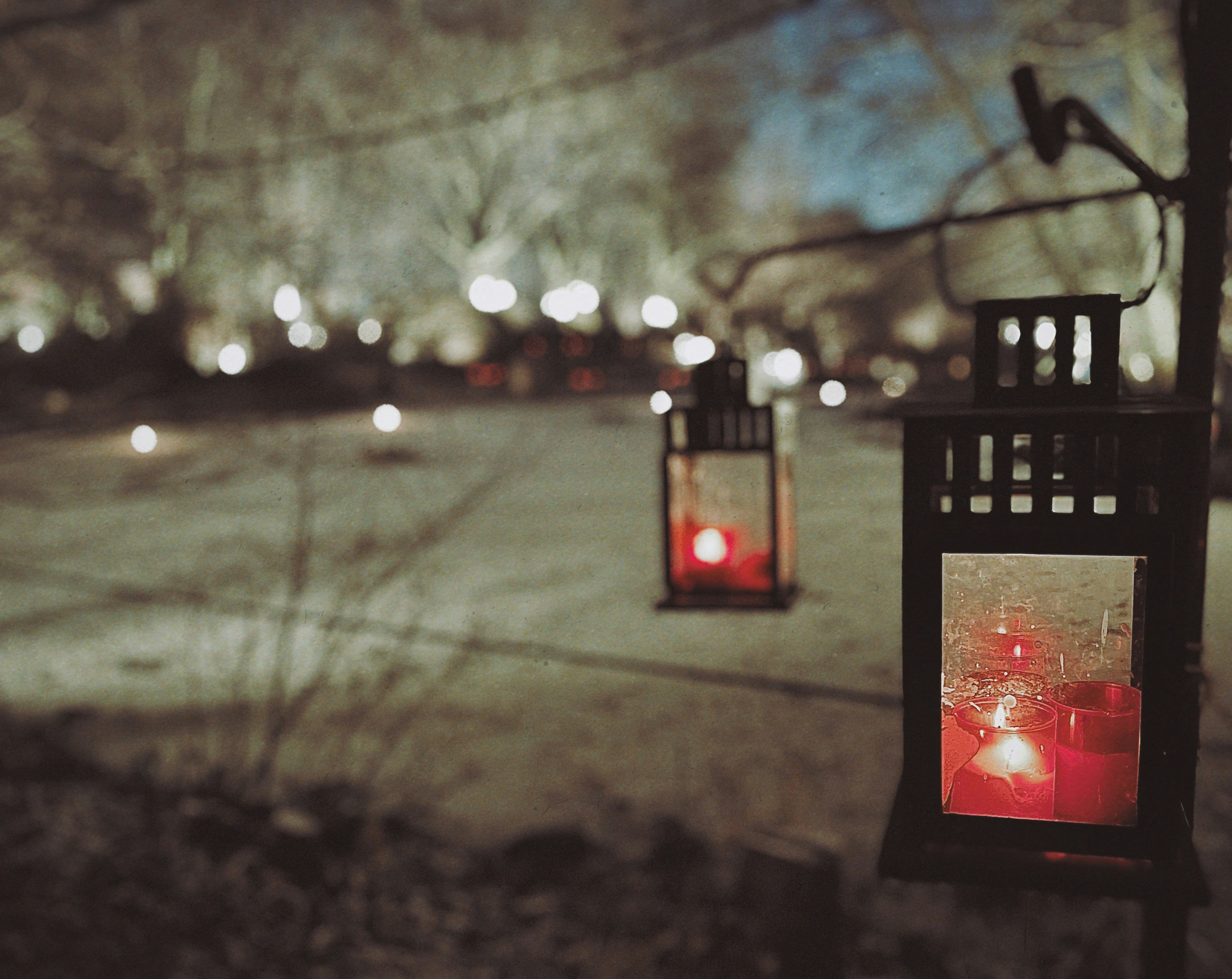 A couple of red candles that are on a pole photo – Free Light Image on ...