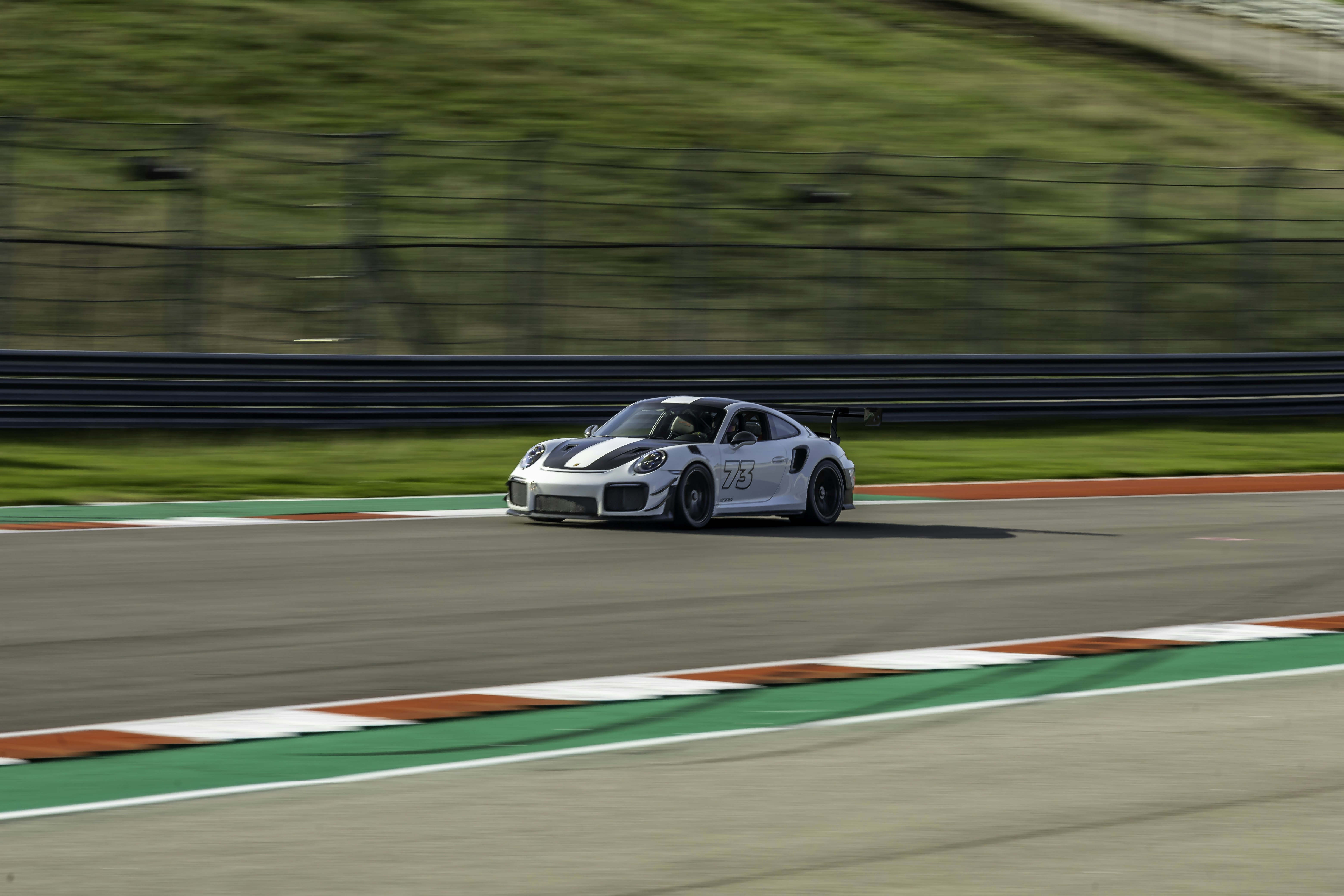 A white car driving down a race track photo – Free Cota Image on Unsplash