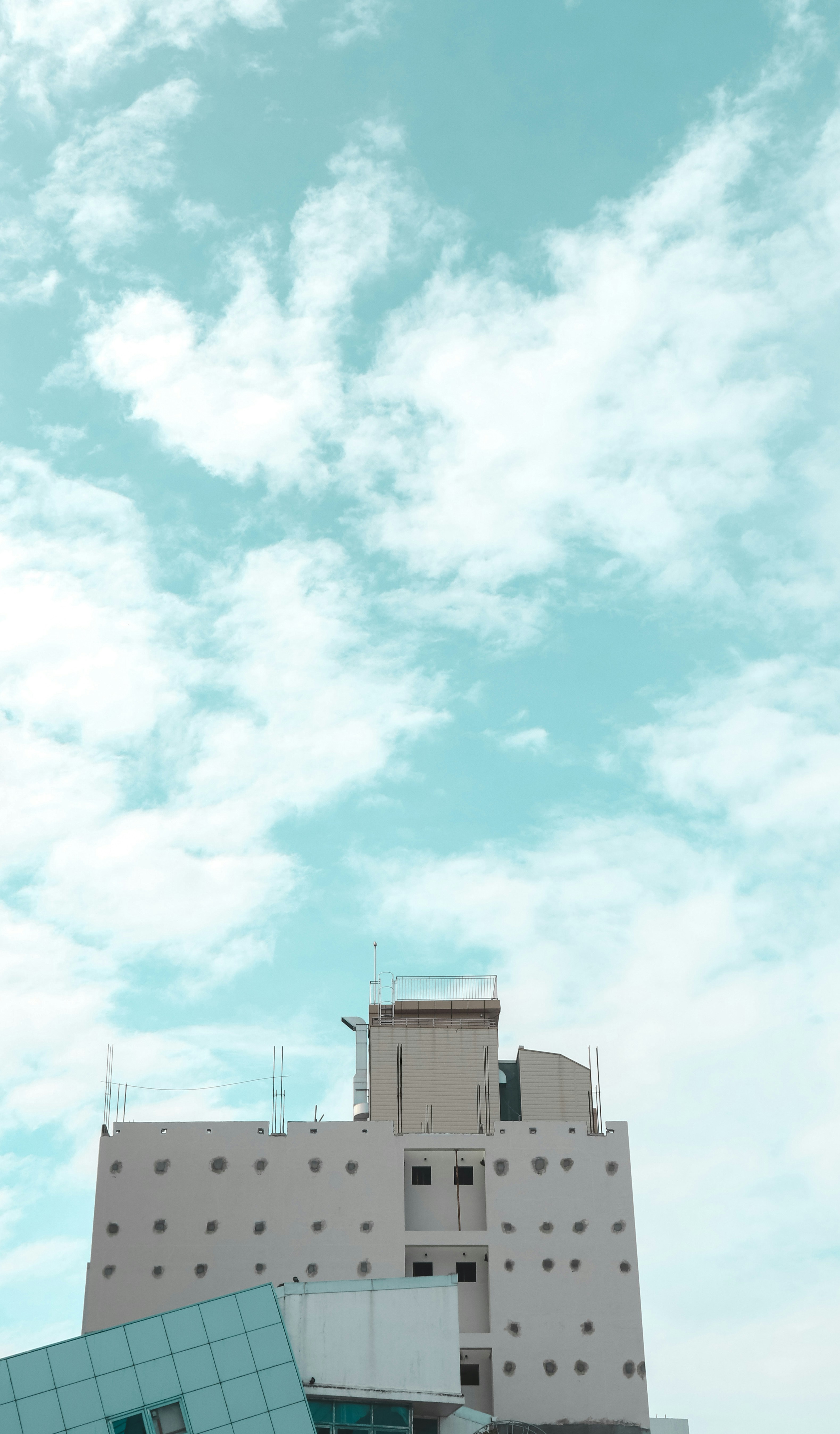 Turquoise Glass Meets Sky-Blue Canopy: A Minimal Urban Vista