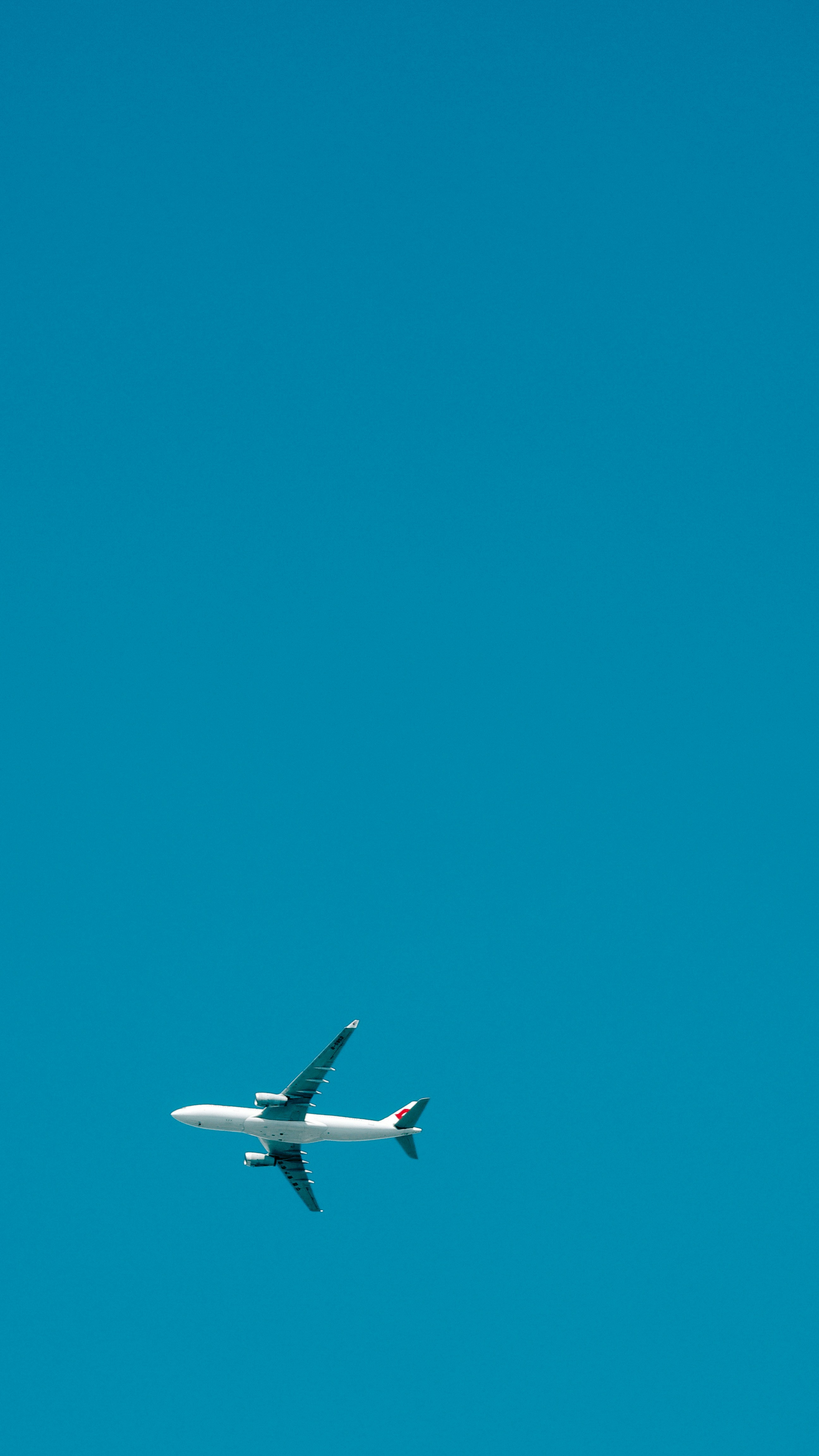 a large jetliner flying through a blue sky