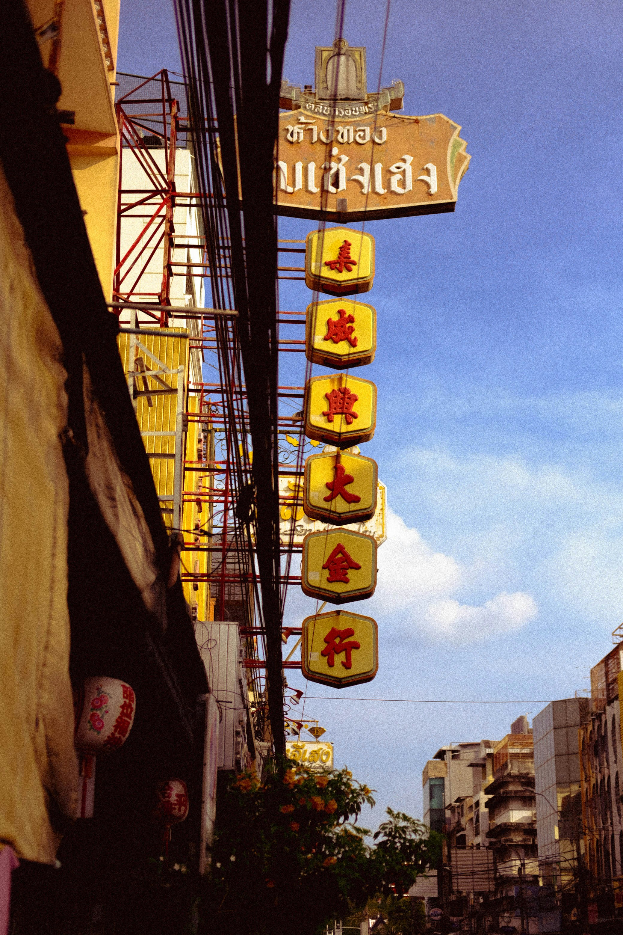 Cascade of Yellow Lanterns Over a Chinatown Street Under a Clear Blue Sky