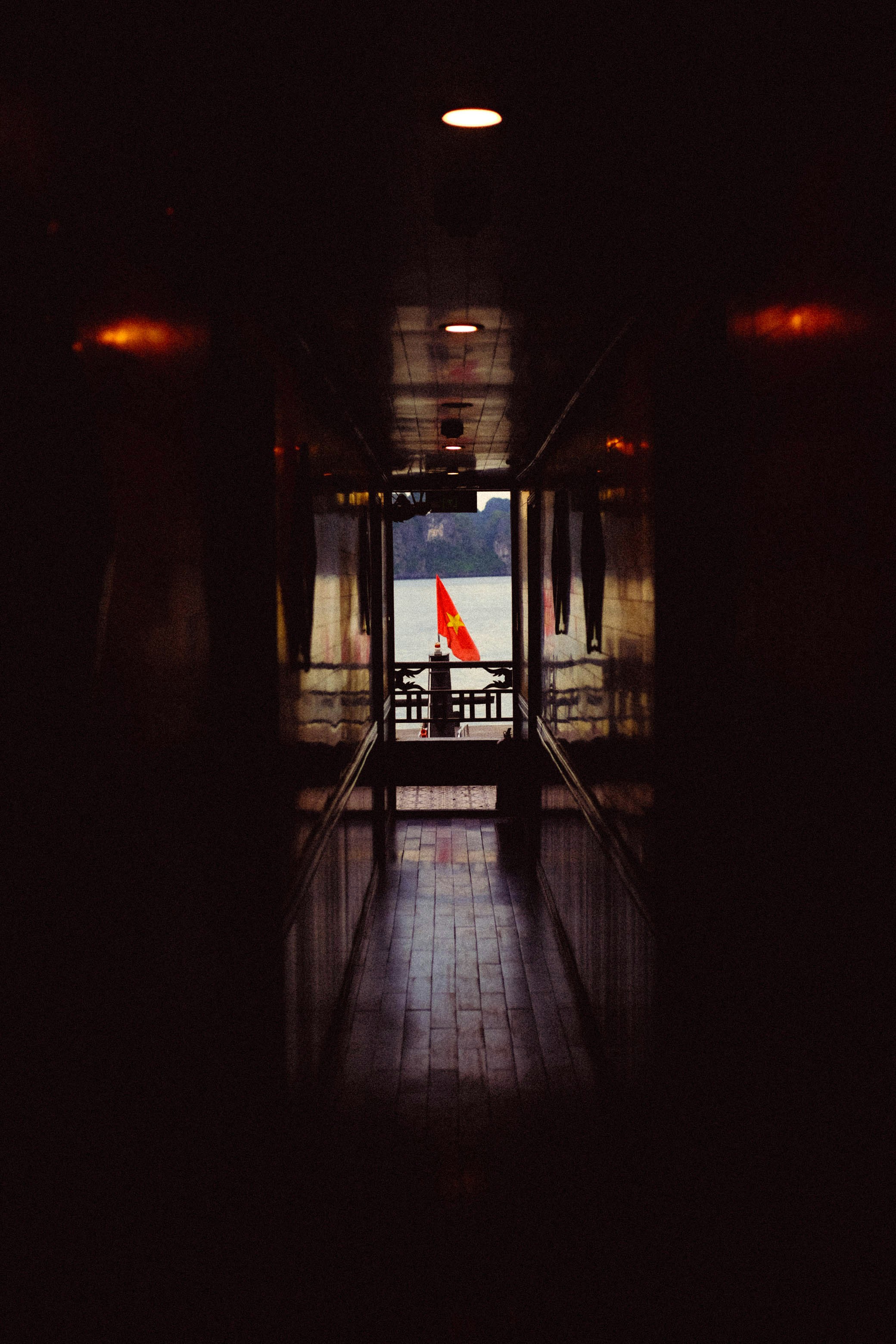 A long hallway with a red and white airplane in the distance photo ...