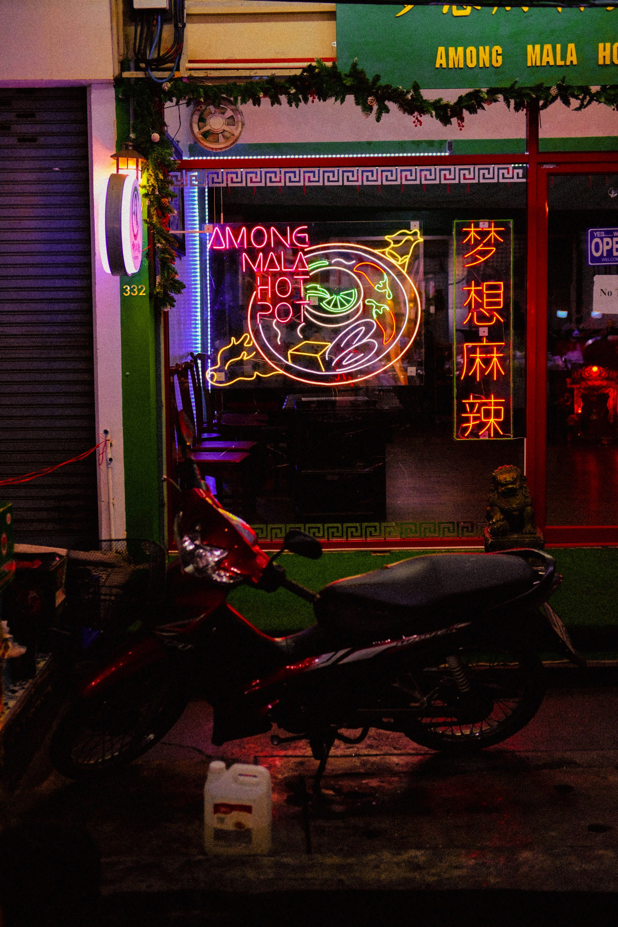 a motorcycle parked in front of a neon sign