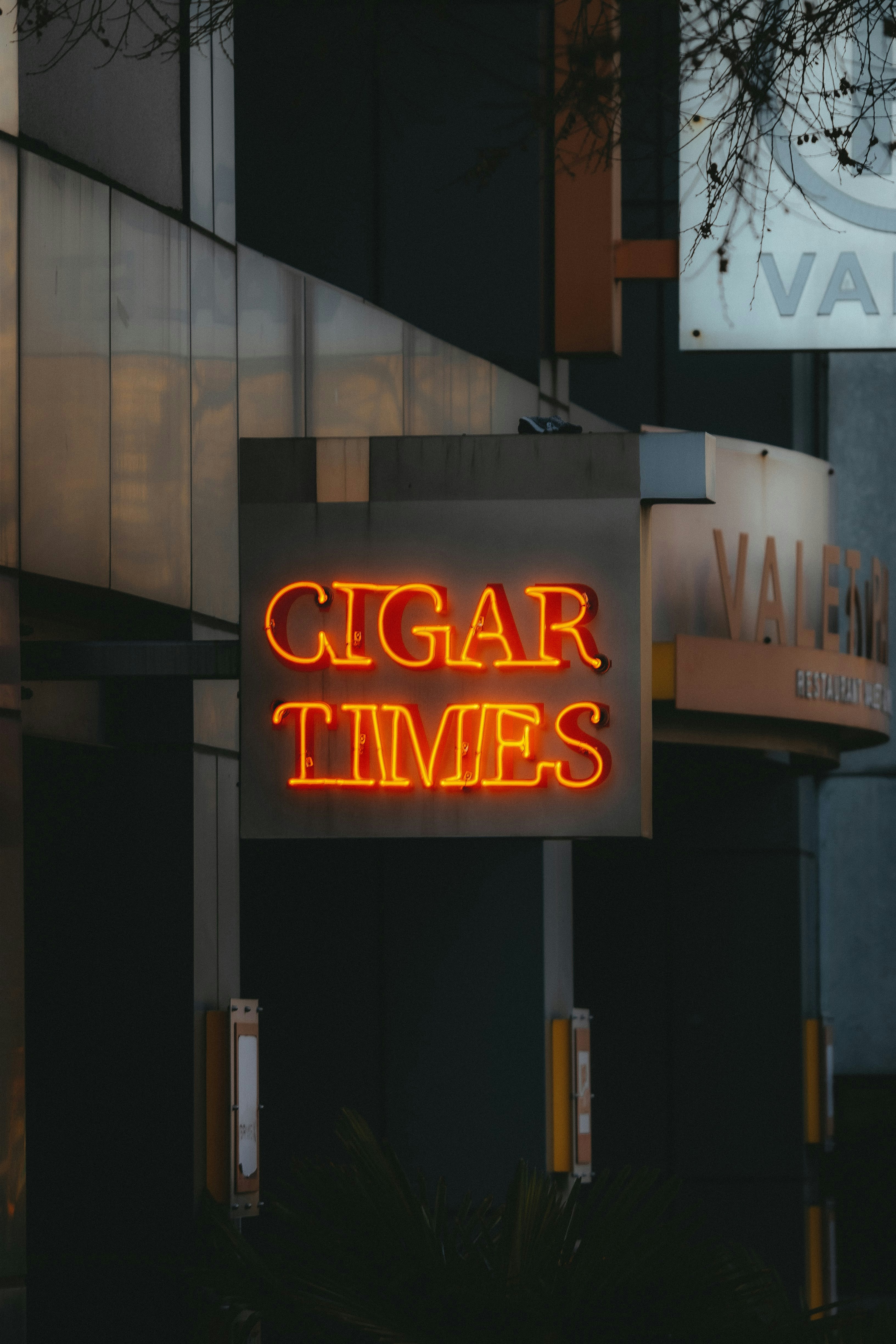 A neon sign that reads cigar times on a building photo – Free Street ...