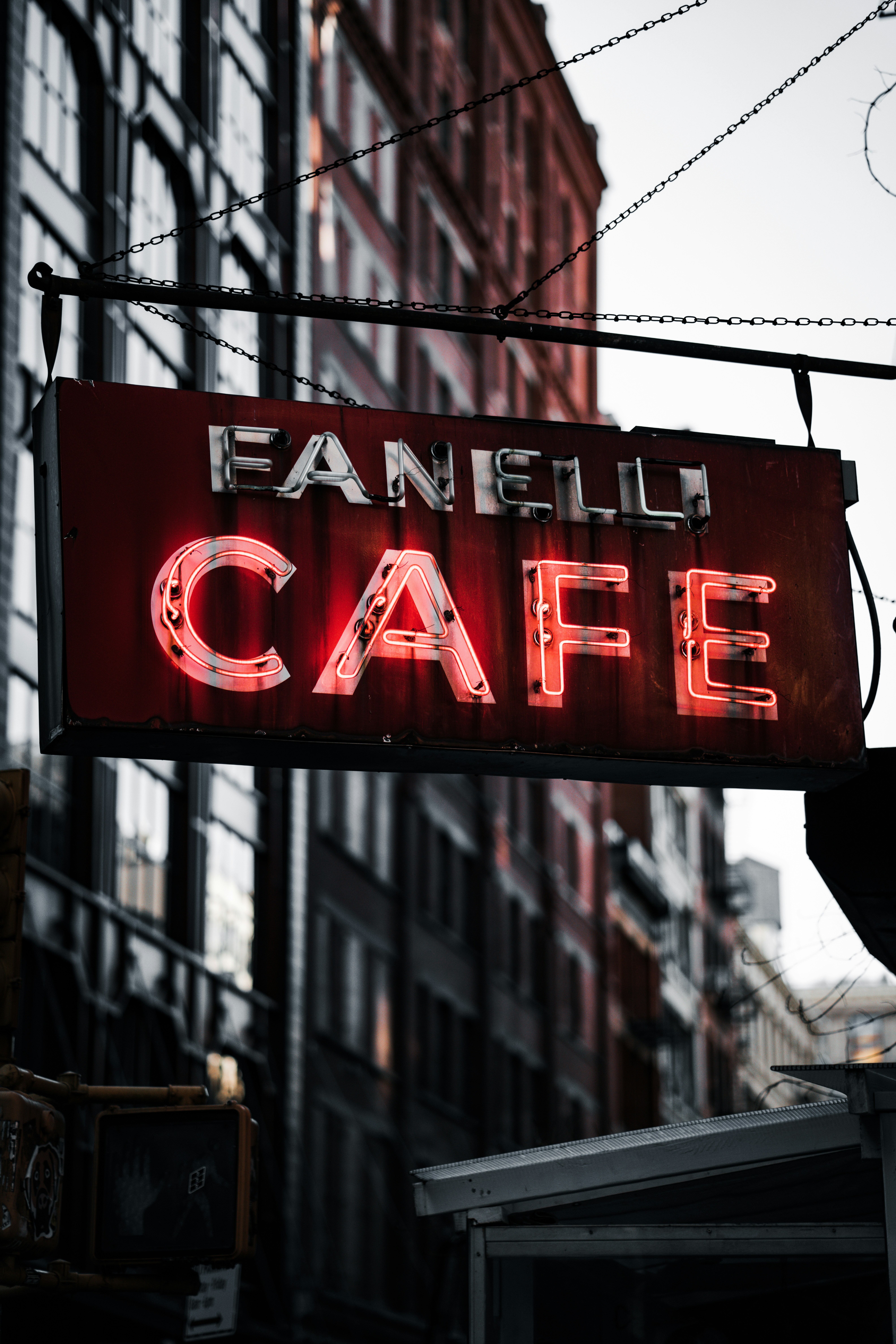 A neon sign hanging from the side of a building photo – Free Soho Image ...