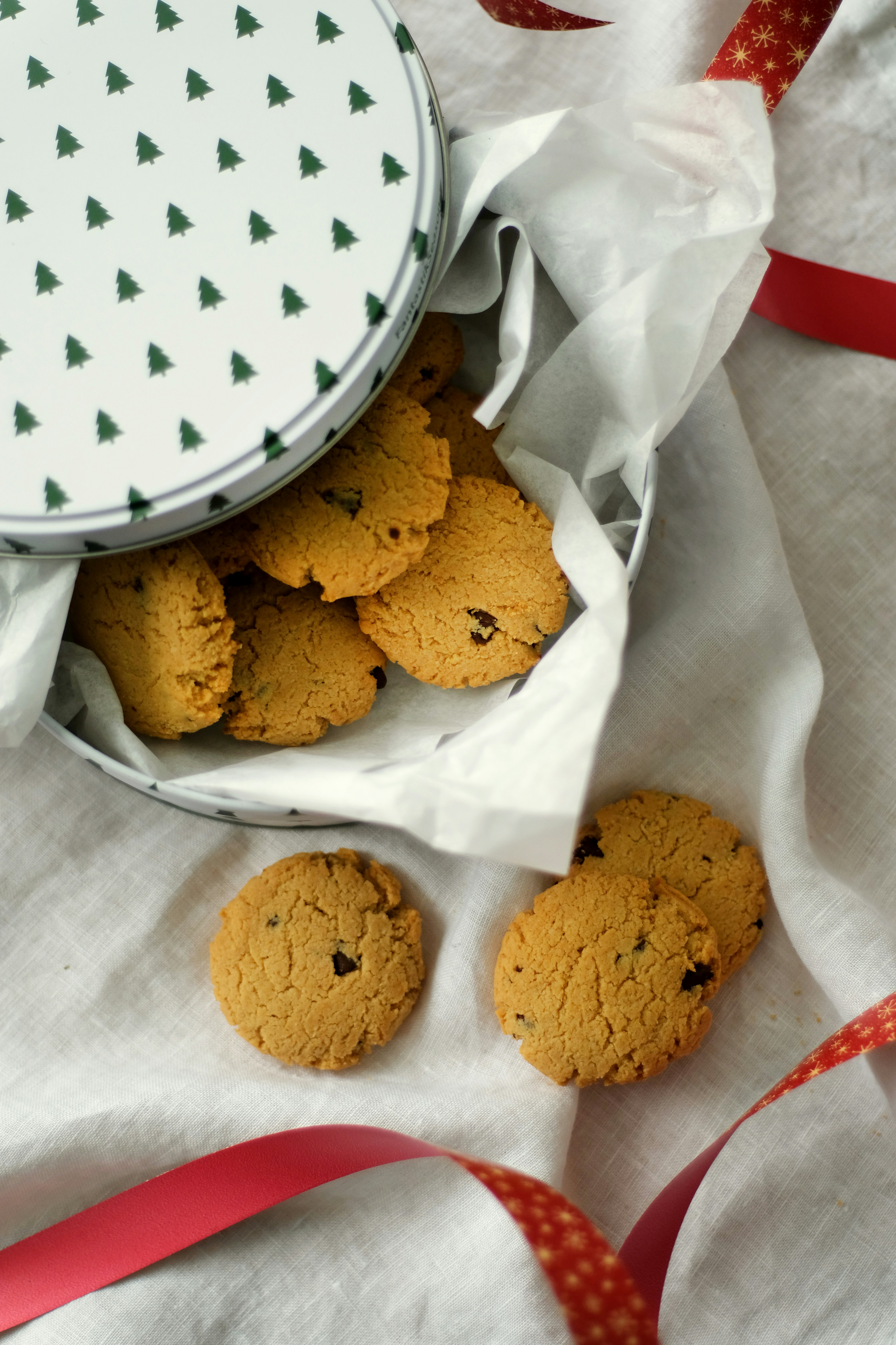 Holiday Crunch in a Decorated Tin: Cookies Nestled with Tissue and Ribbon