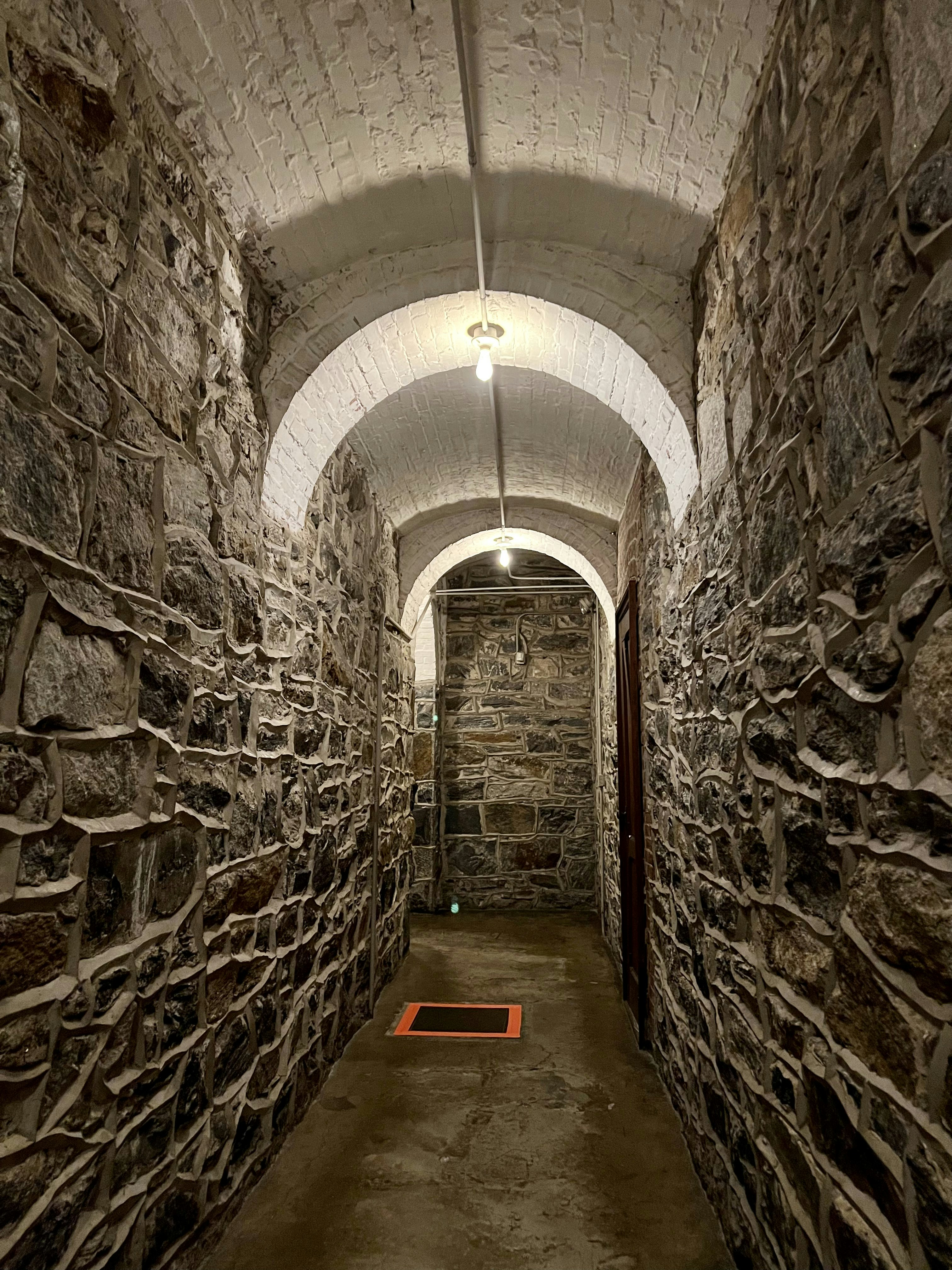 As you walk down the Stone Hallway of the historic Biltmore House in Asheville, NC, you can see one of its massive foundation walls. Per Biltmore literature, "it took almost two years to build the foundations and footings that extend down about 29 feet."