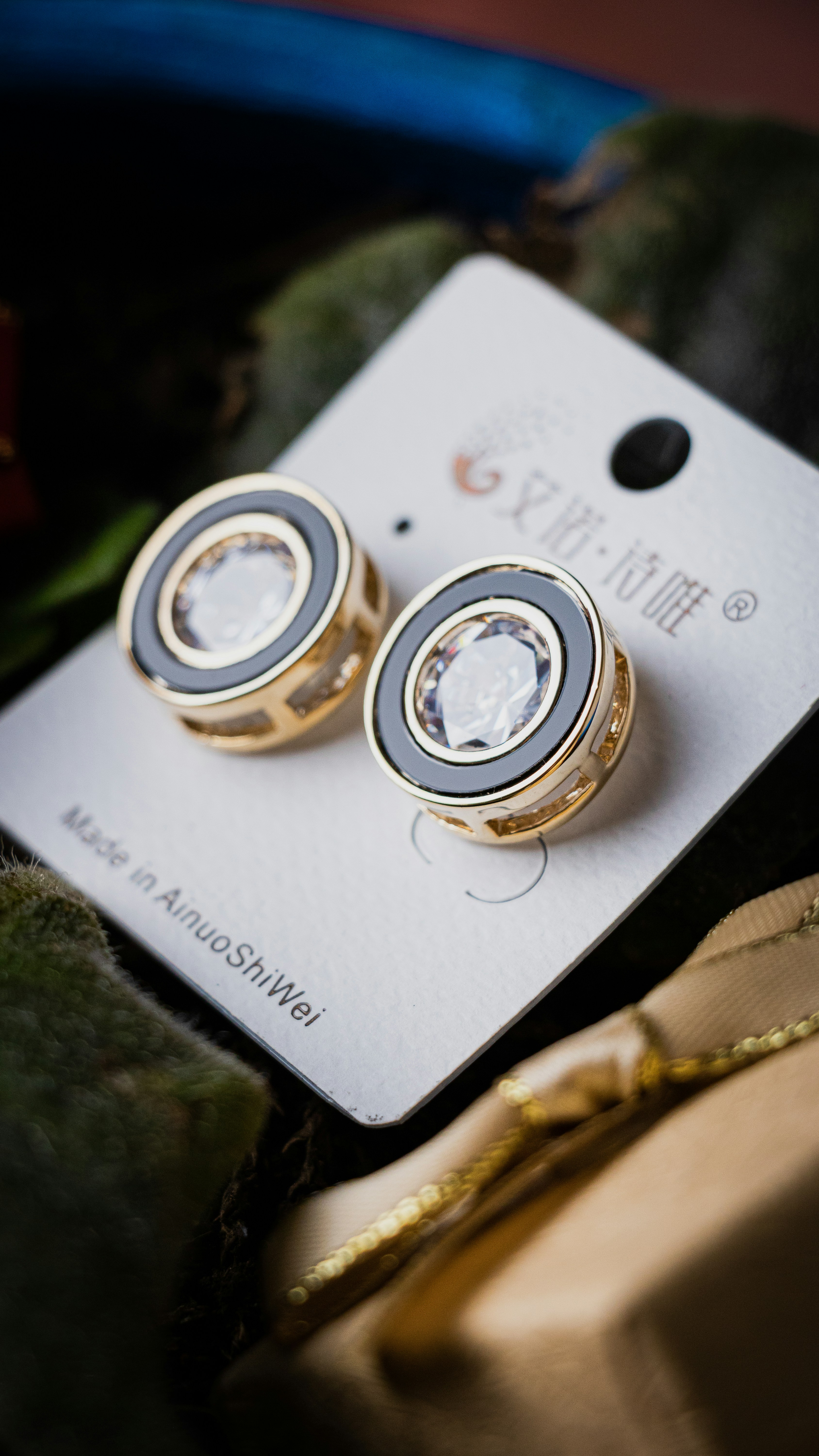 Gleaming Circular Studs on a White Card: Gold, Black and Crystal Accents