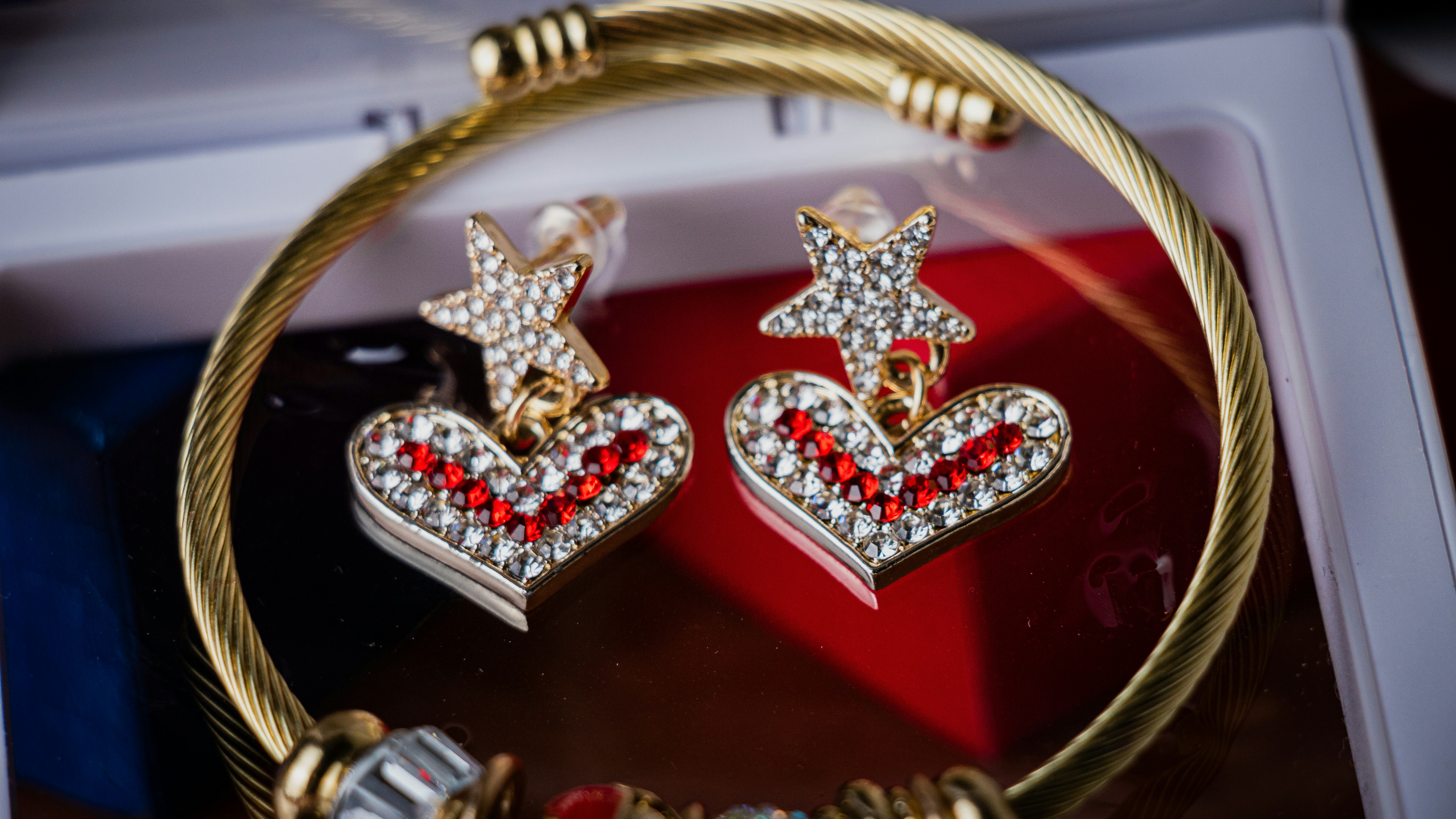 Twin Heart Earrings Sparkle in a Golden Ring
