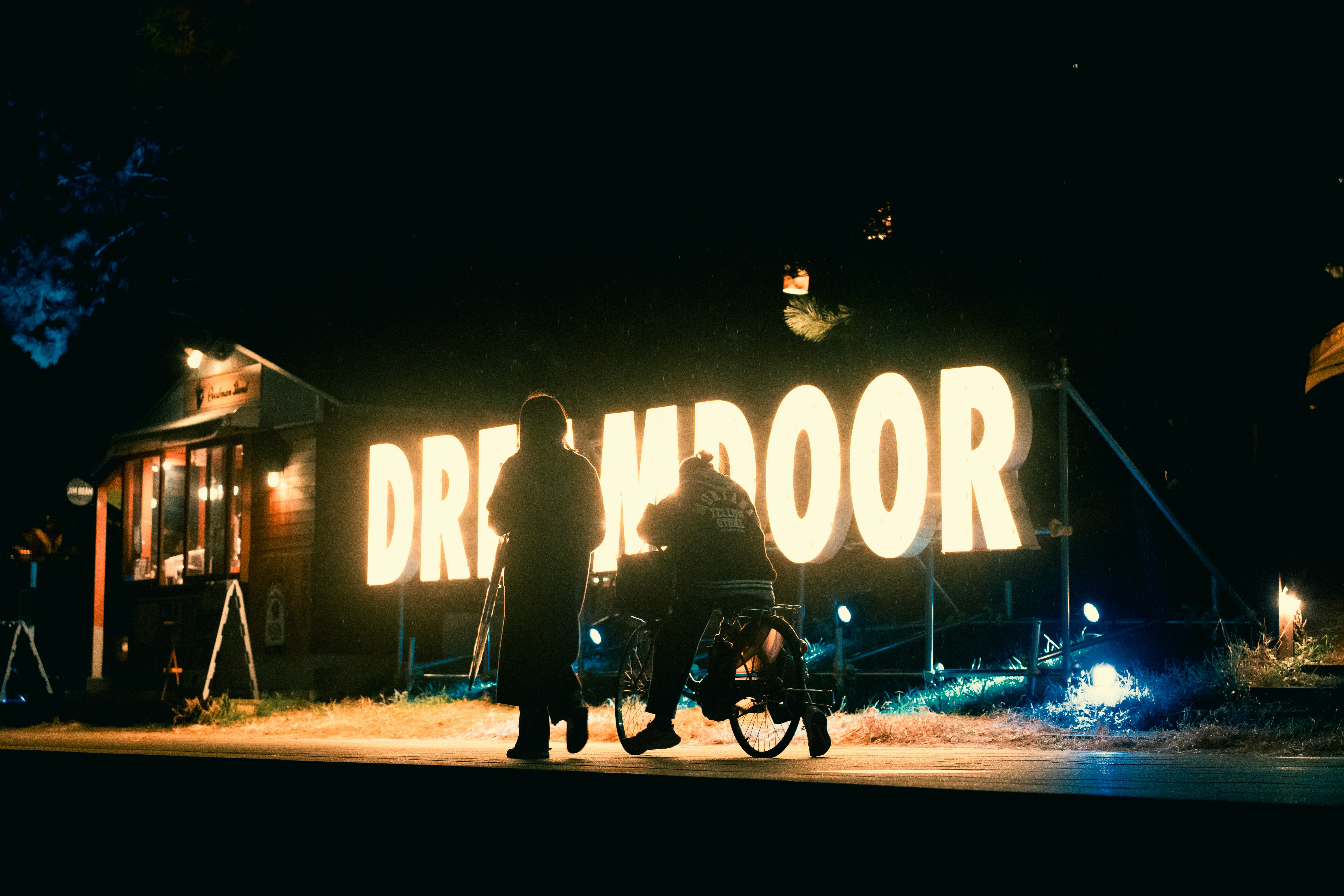 A couple of people standing next to a sign photo – Free 2-14-1 shinko ...